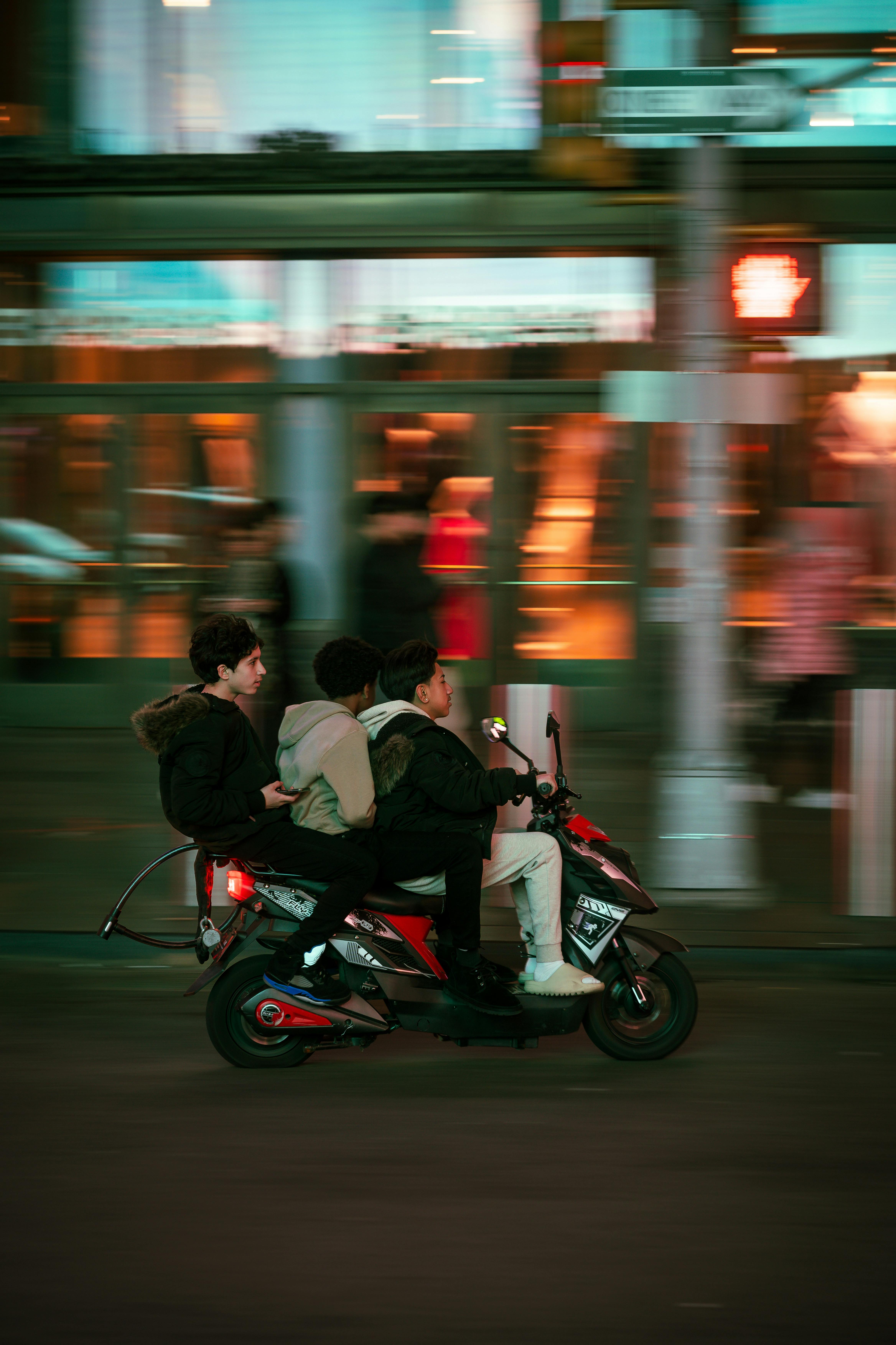 Three Young Men Riding on a Scooter · Free Stock Photo