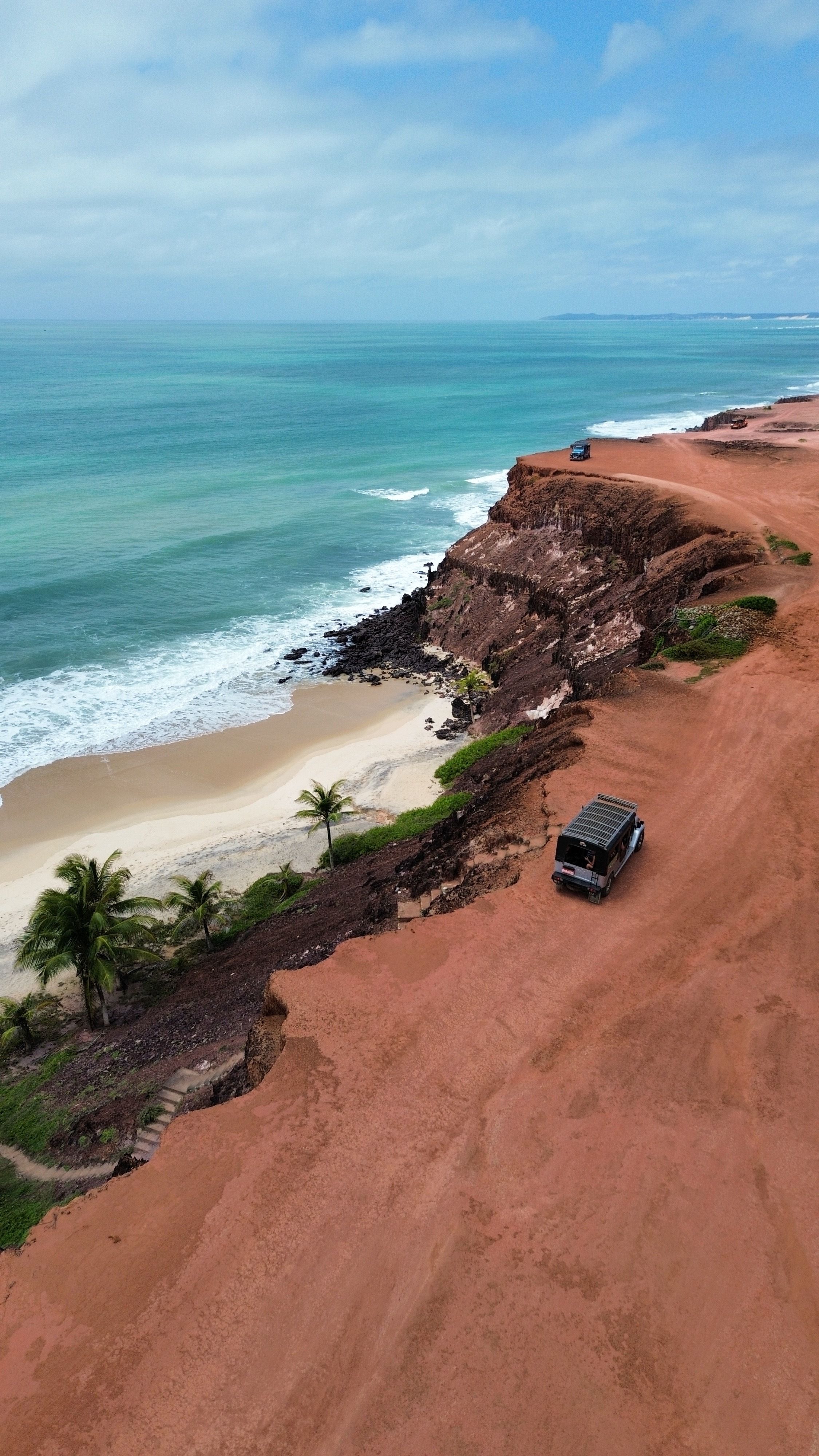 Car with Tourists on Dirt Road Along the Cliff · Free Stock Photo