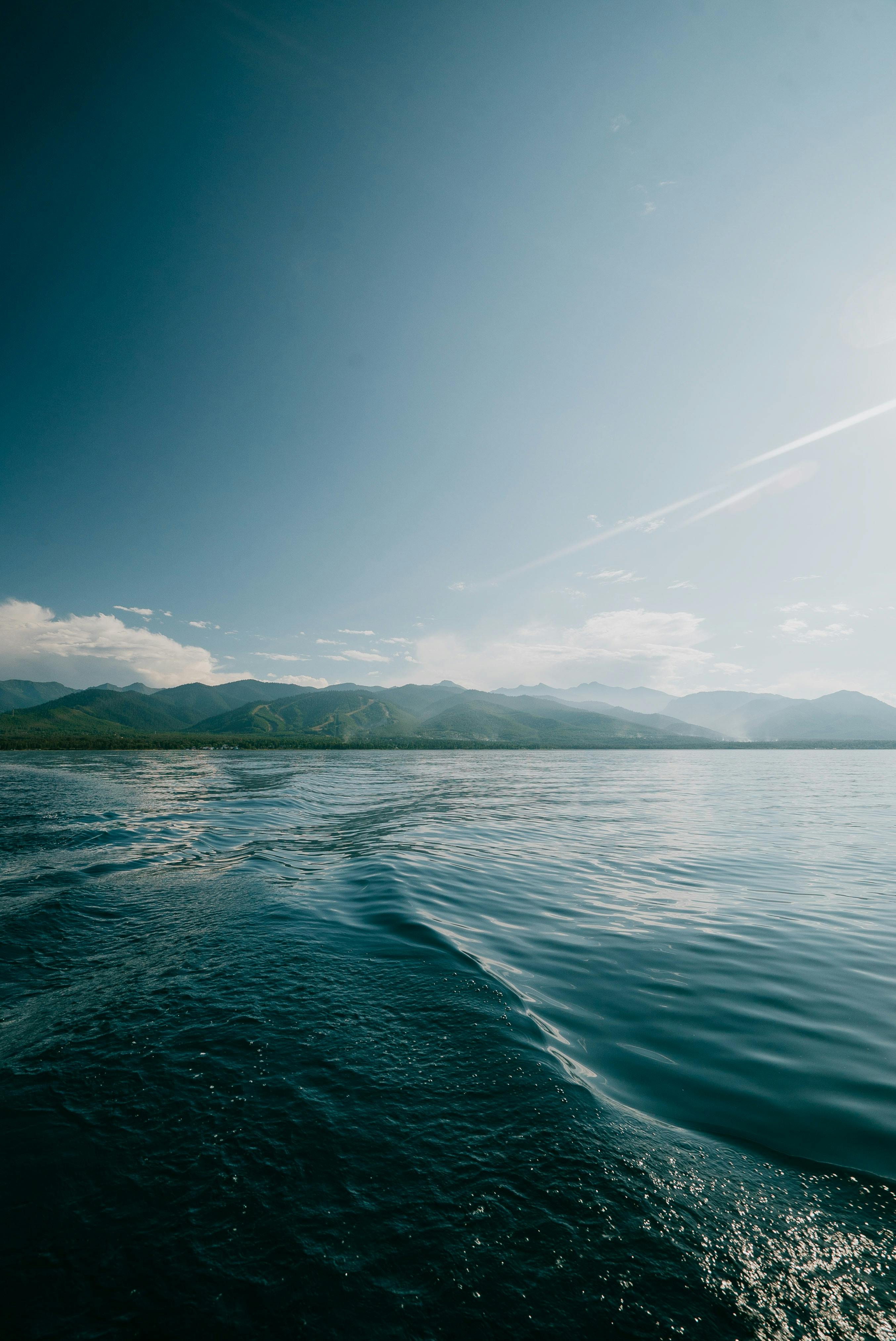 Surface of a Lake with Hills in the Background · Free Stock Photo