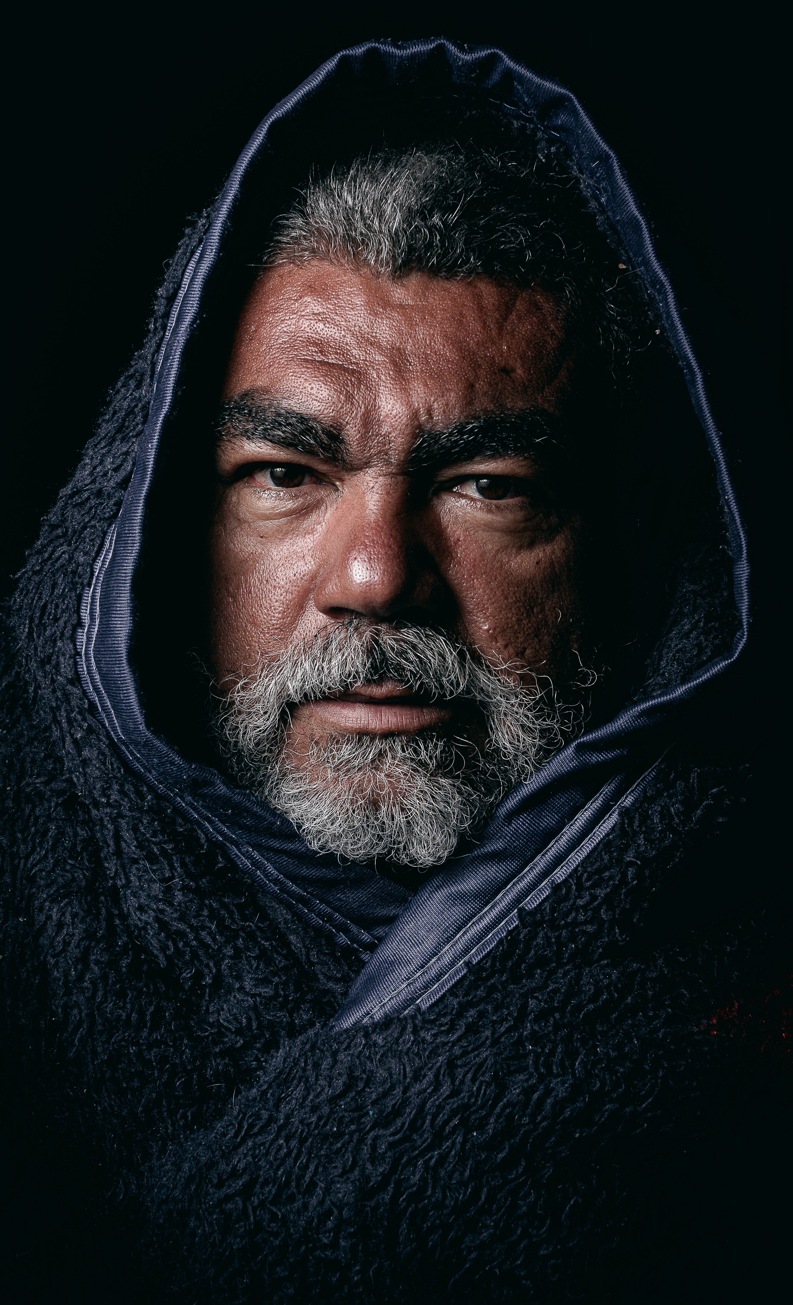 Man in Hood in Smoke on Black Background · Free Stock Photo