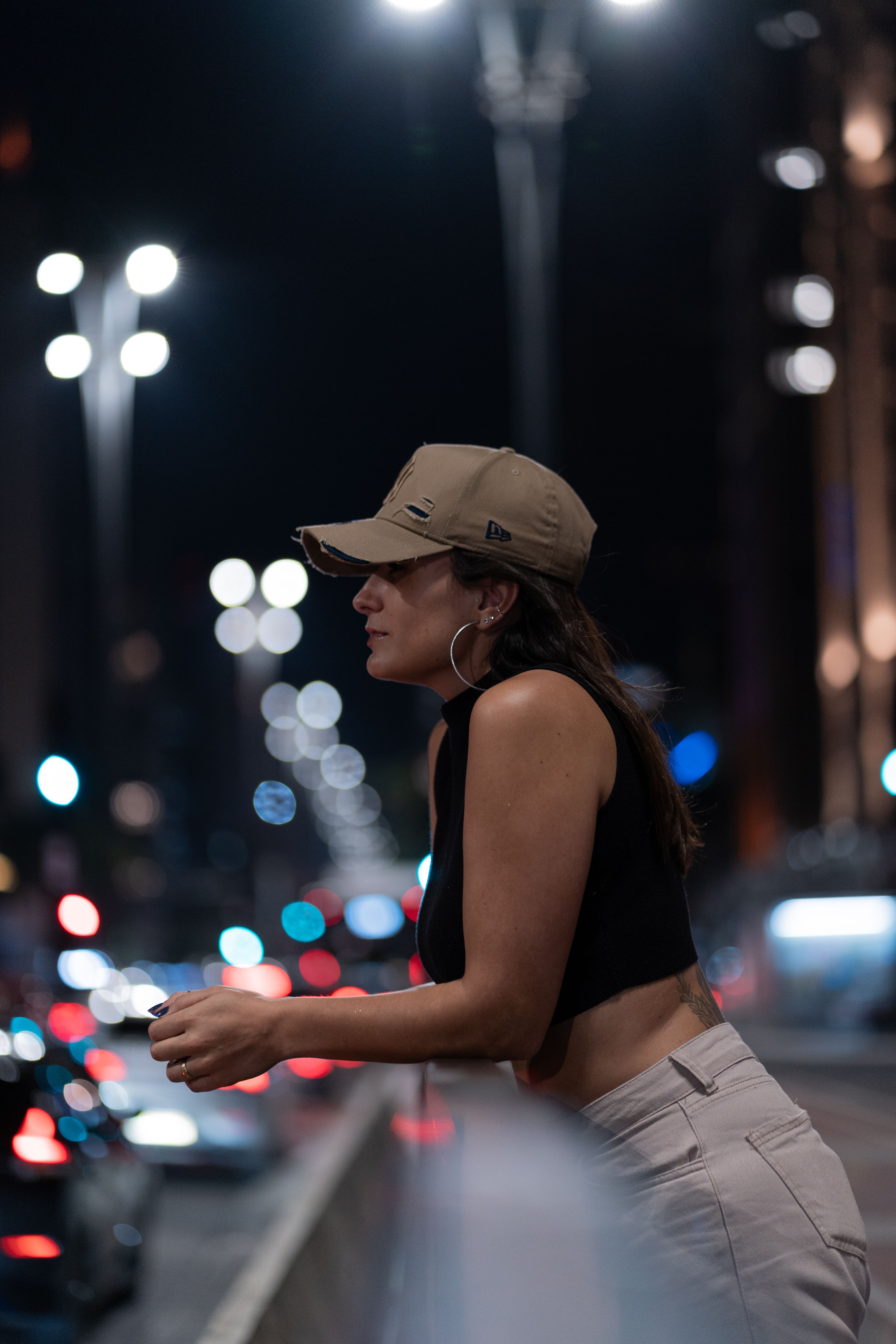 Woman Wearing a Cap in a City at Night · Free Stock Photo