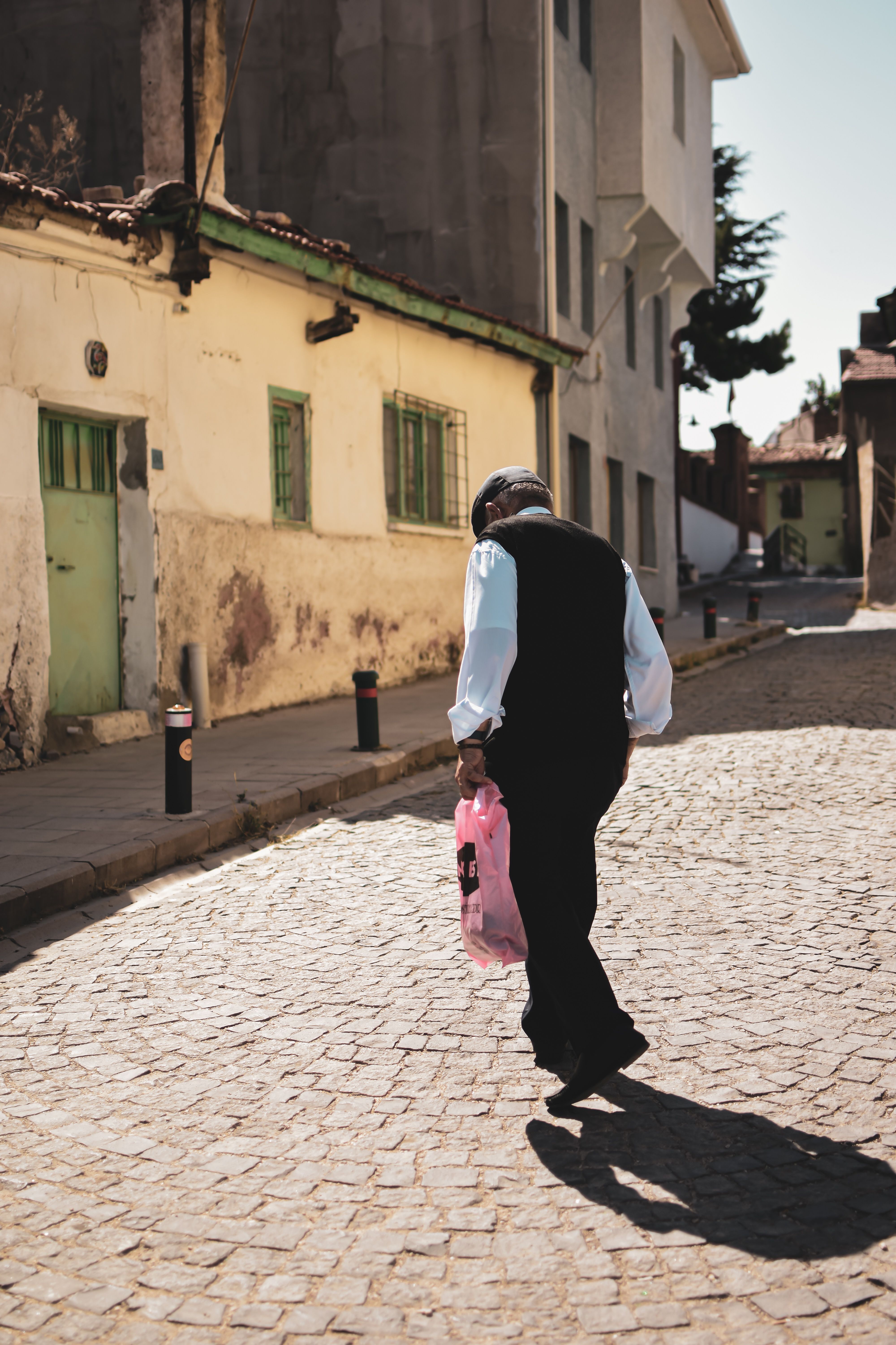Old-fashioned Dressed Man Walking on Paving Street · Free Stock Photo