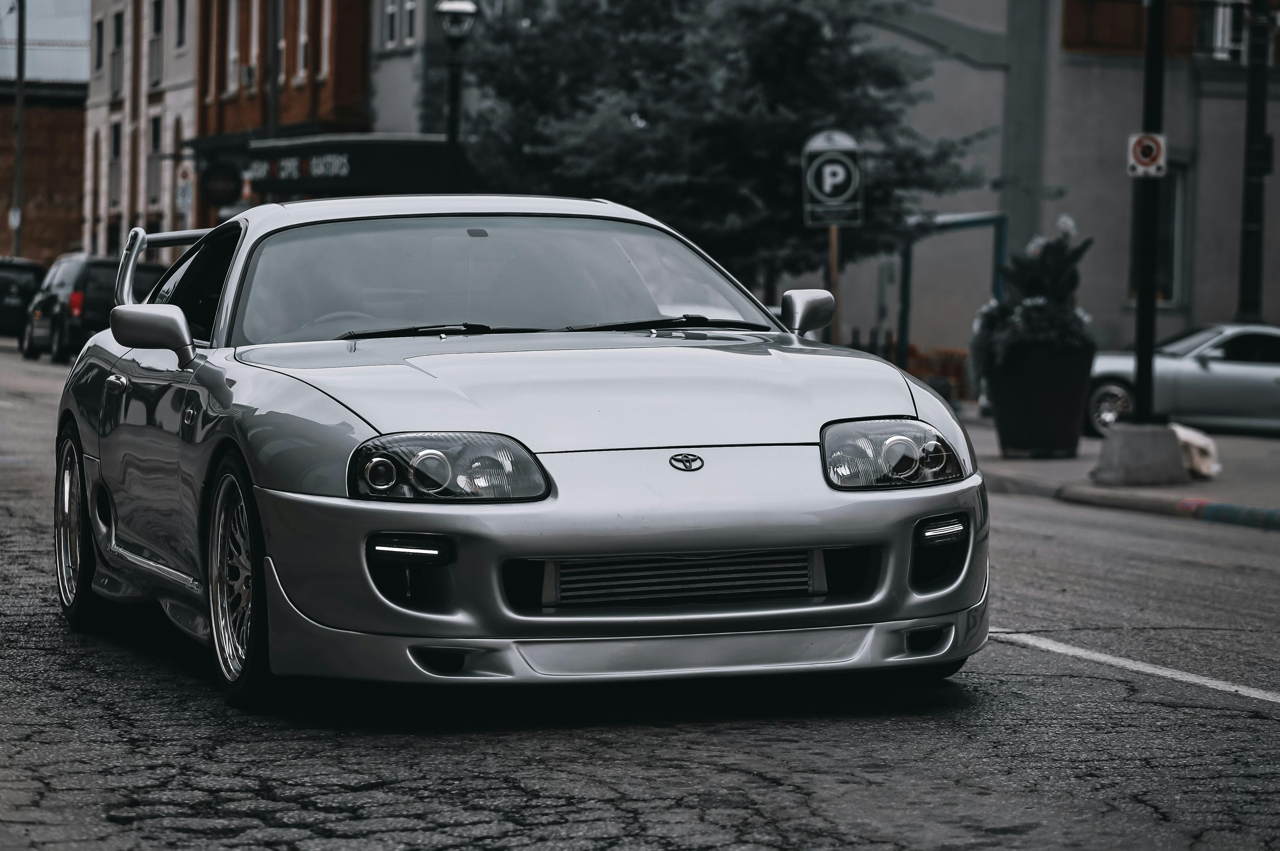 Silver Toyota Supra with Spoiler Parked under Building · Free Stock Photo