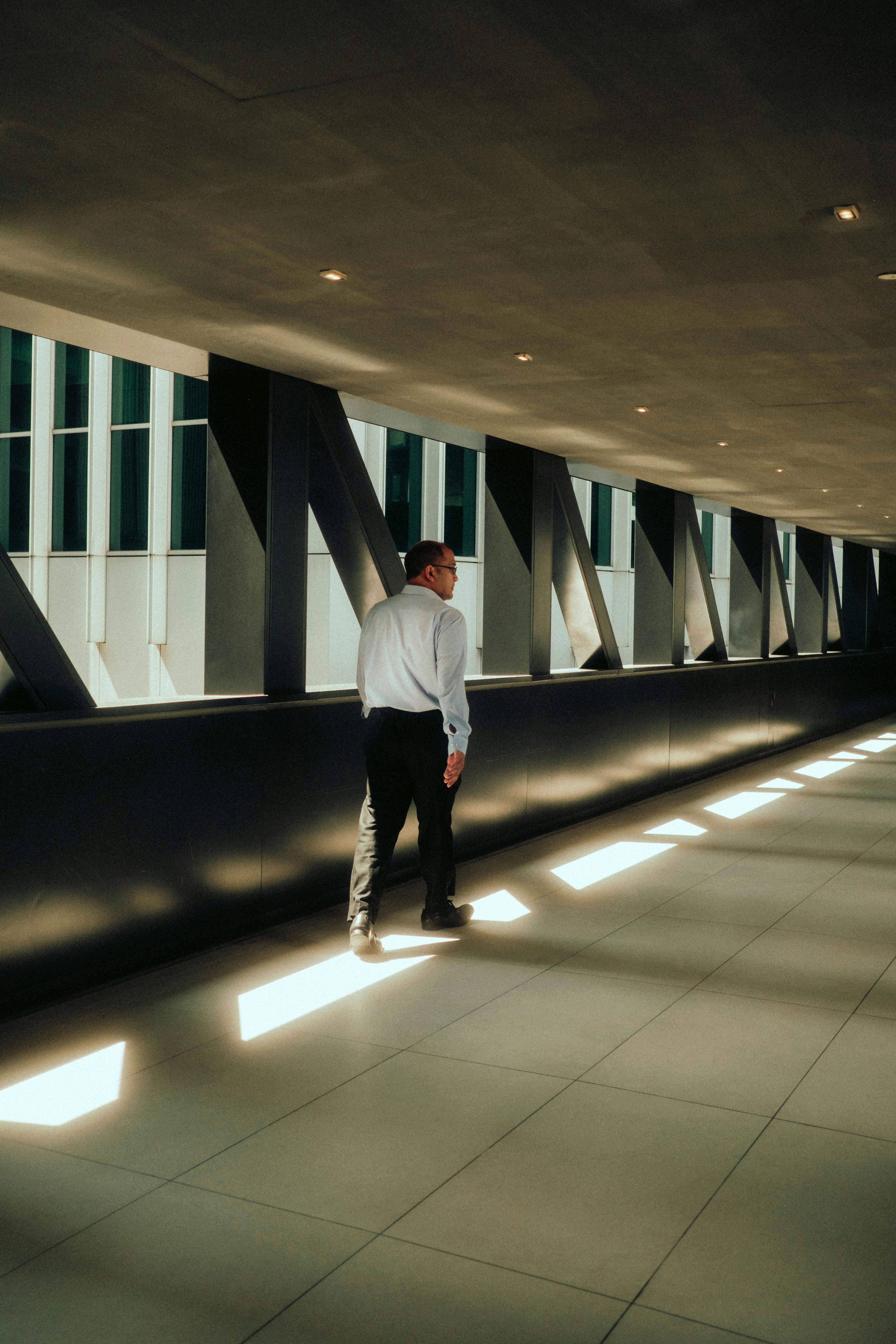 Man Walking in Walkway · Free Stock Photo