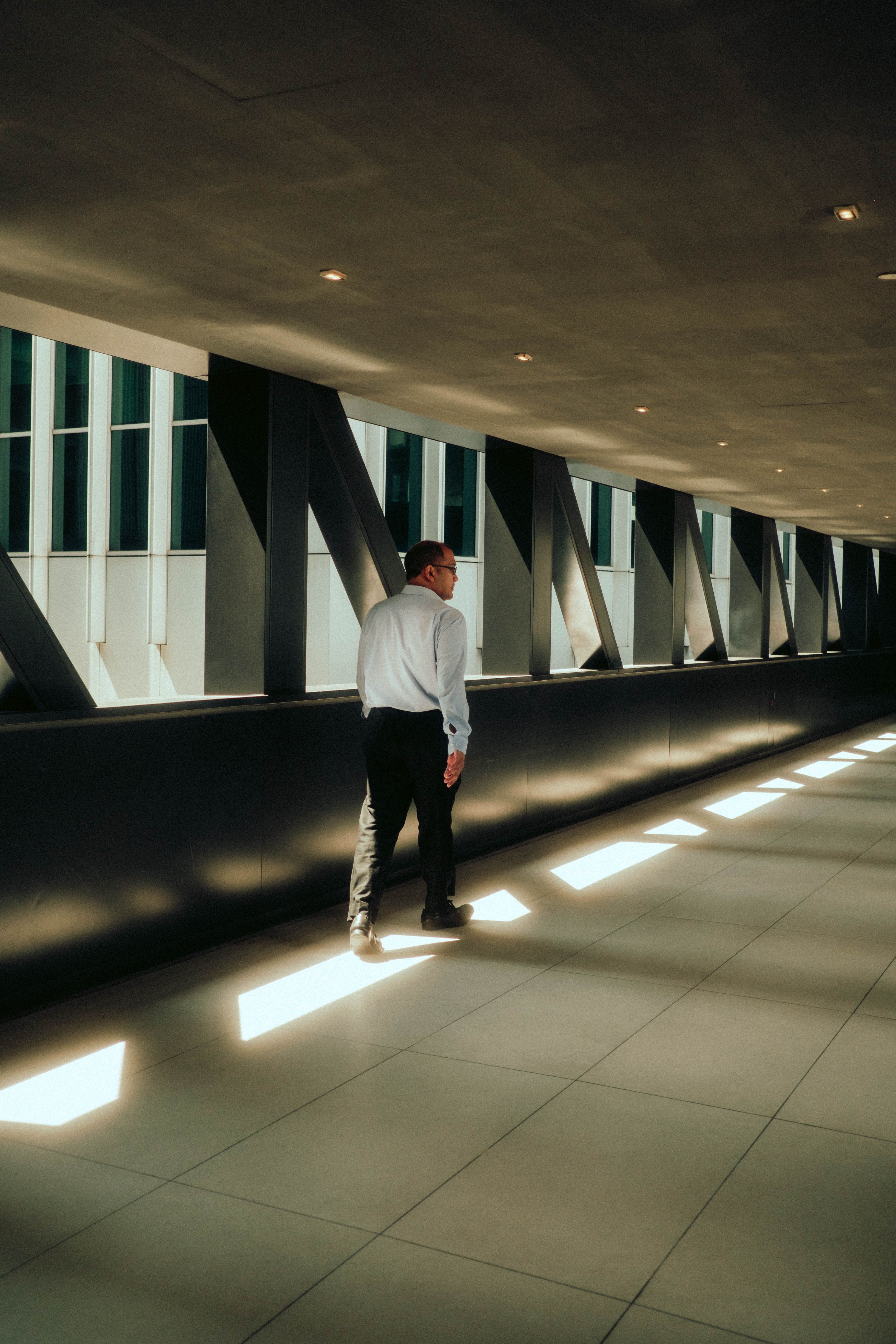 Man Walking in Walkway · Free Stock Photo