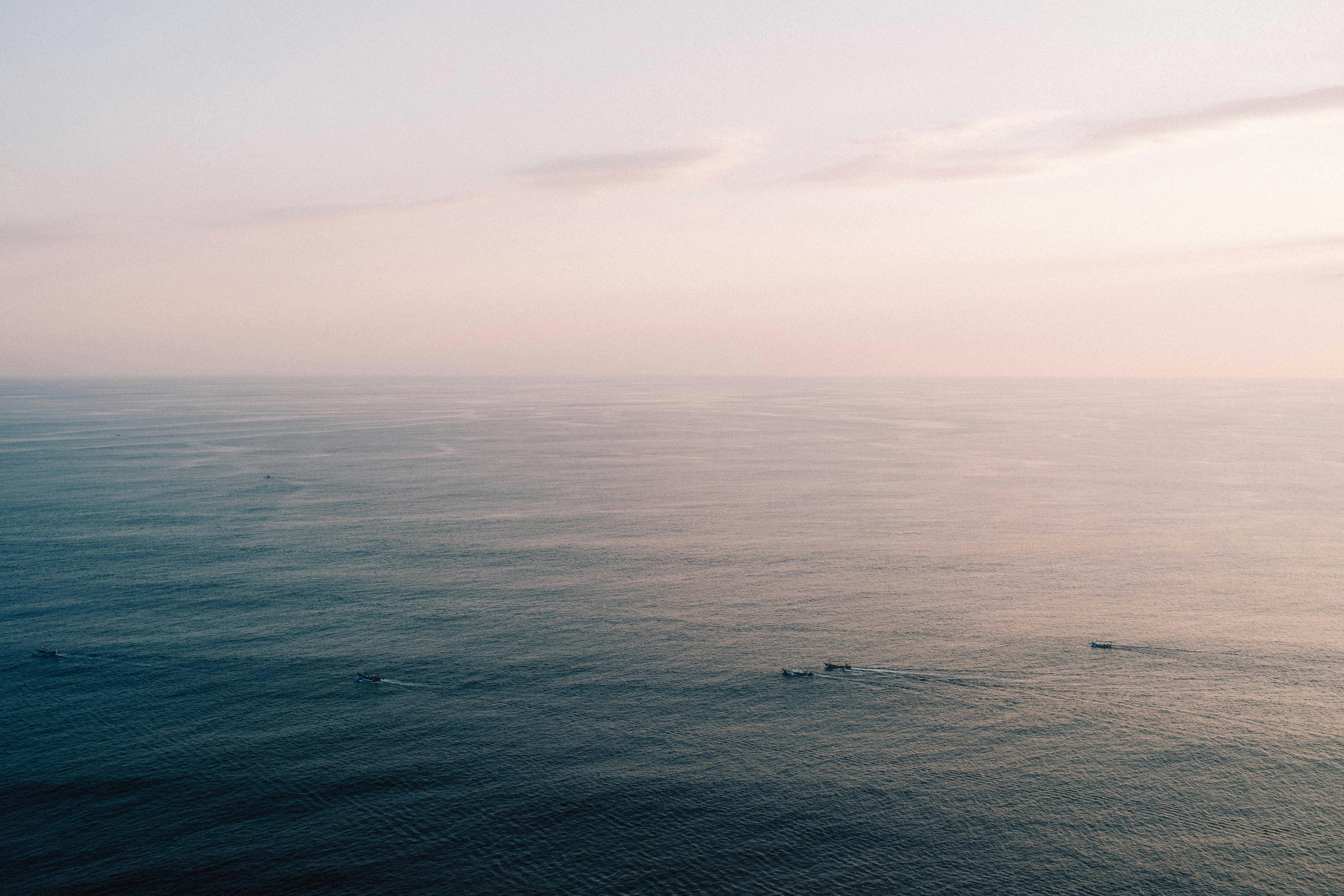 Boats on the Ocean at Dawn · Free Stock Photo