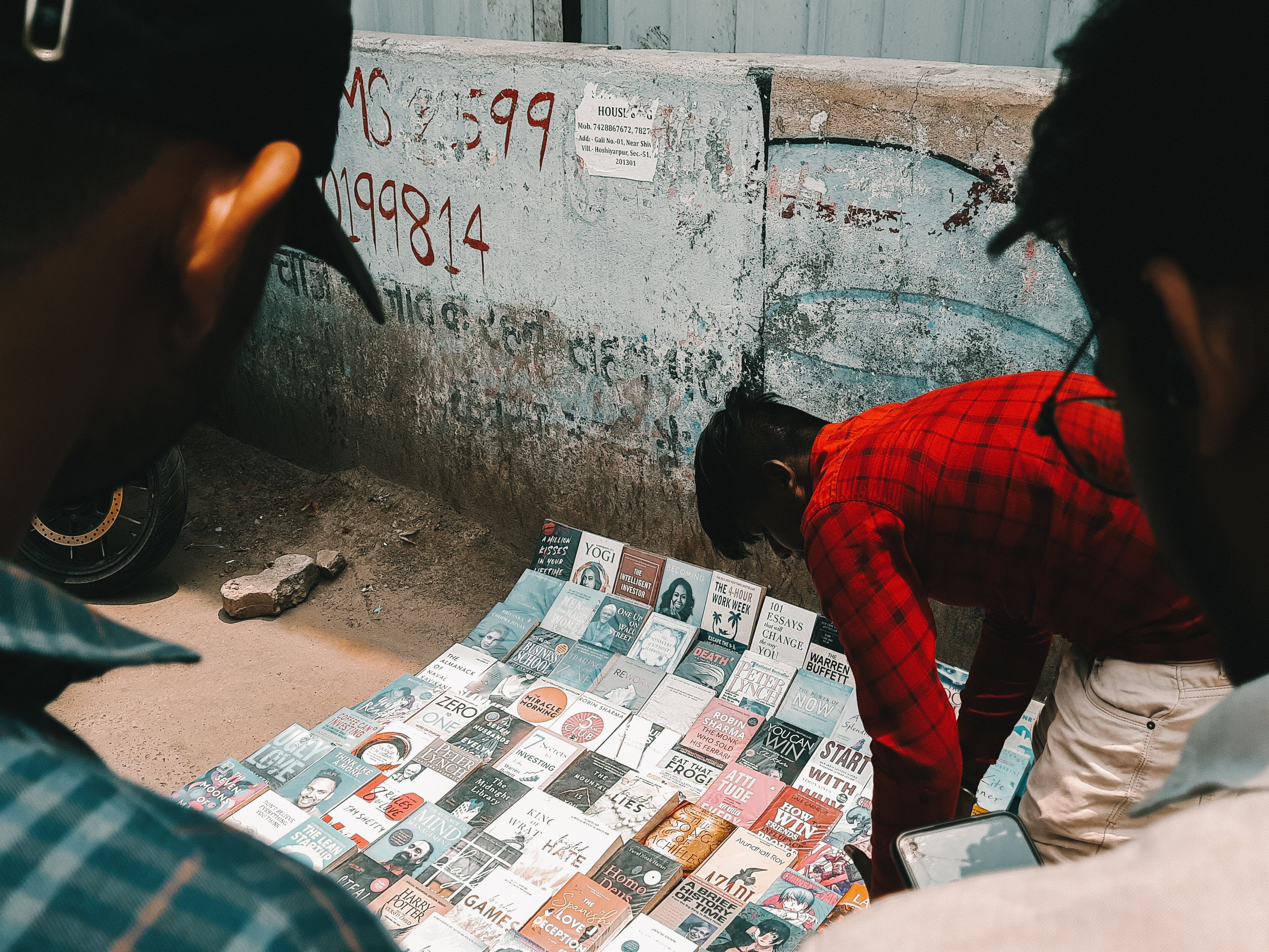 Man Selling Books on Sidewalk · Free Stock Photo