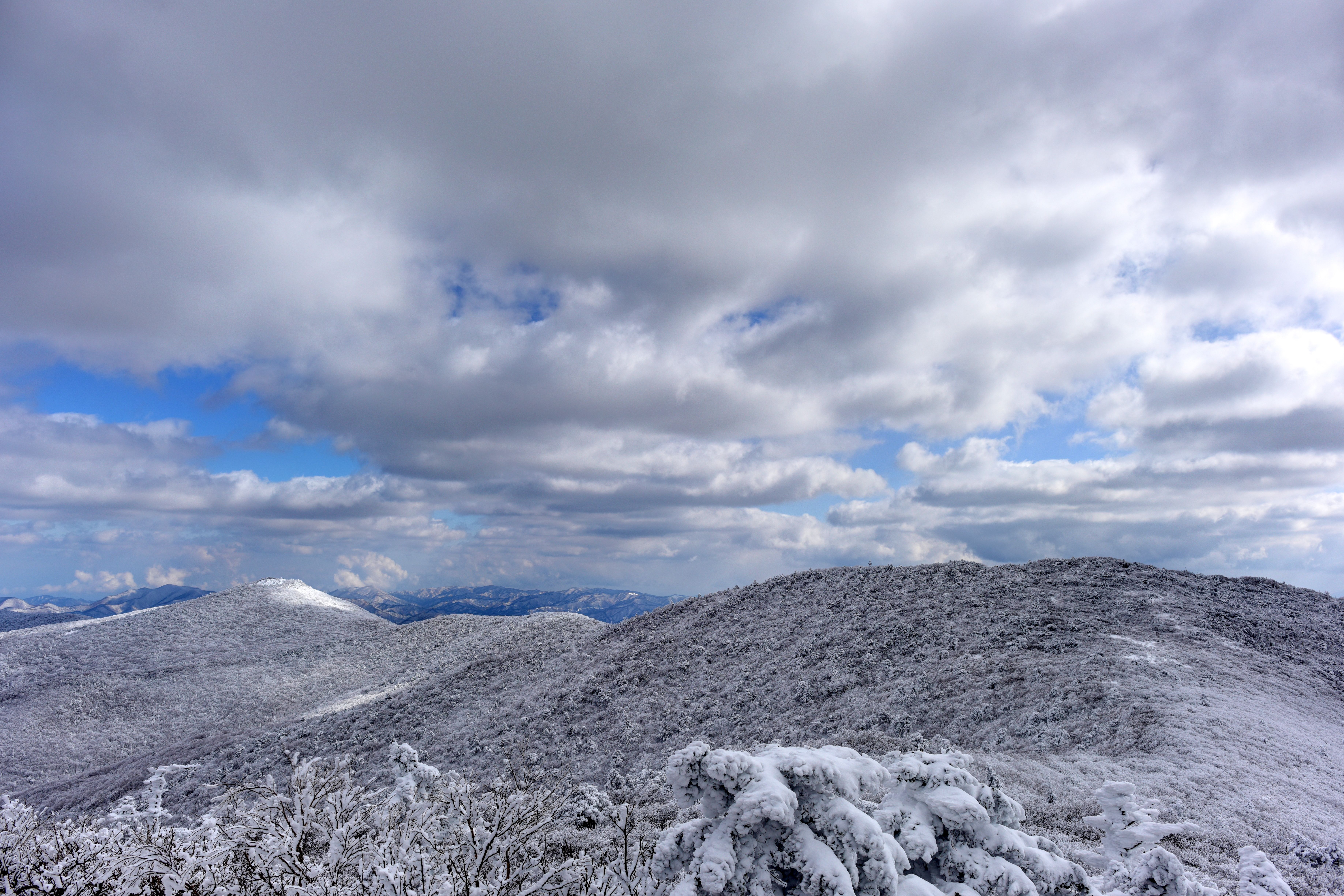 Mountain Peaks Covered in Snow under Cloudy Sky · Free Stock Photo