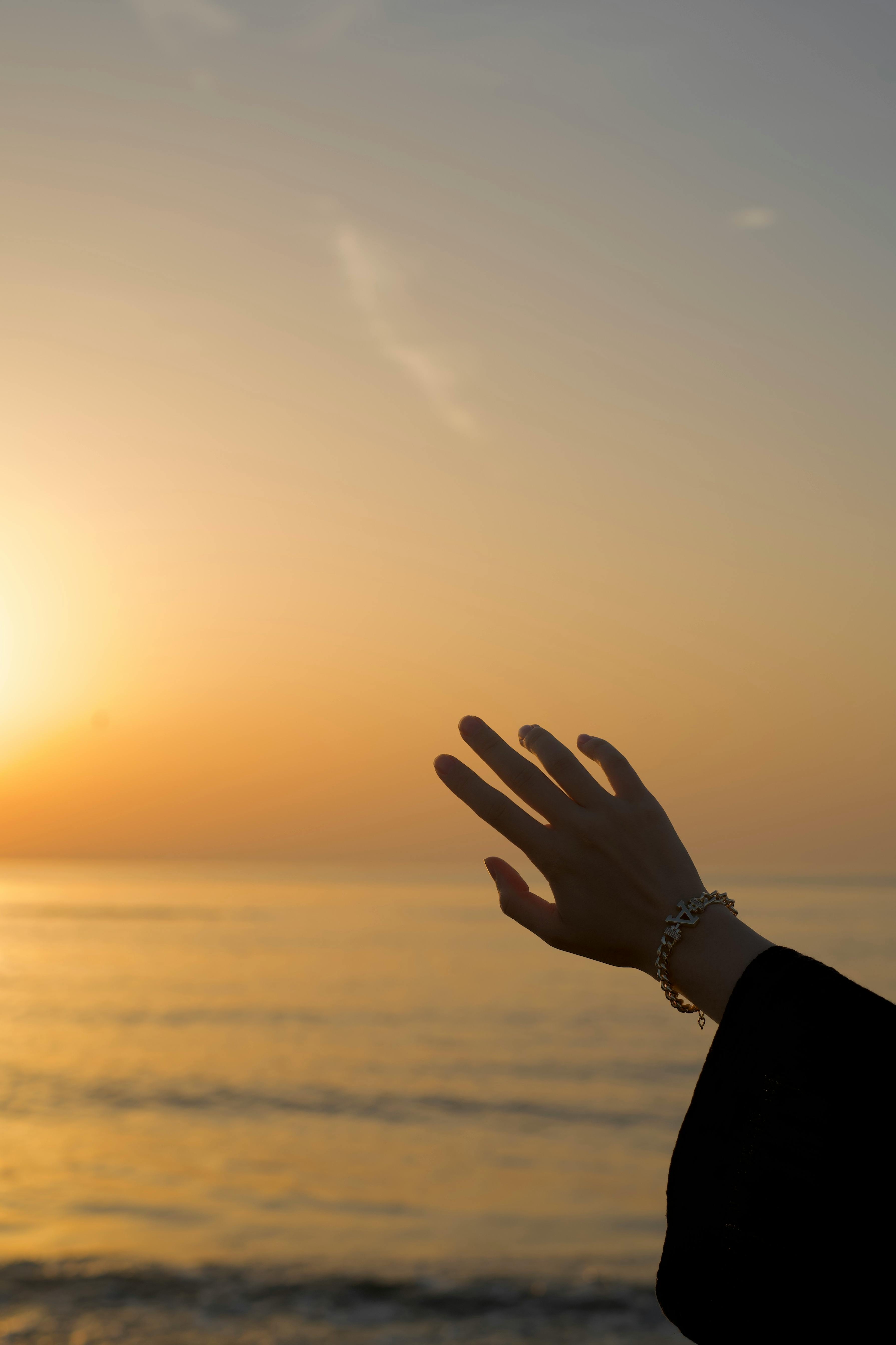 Silhouette of Hand During Sunset · Free Stock Photo