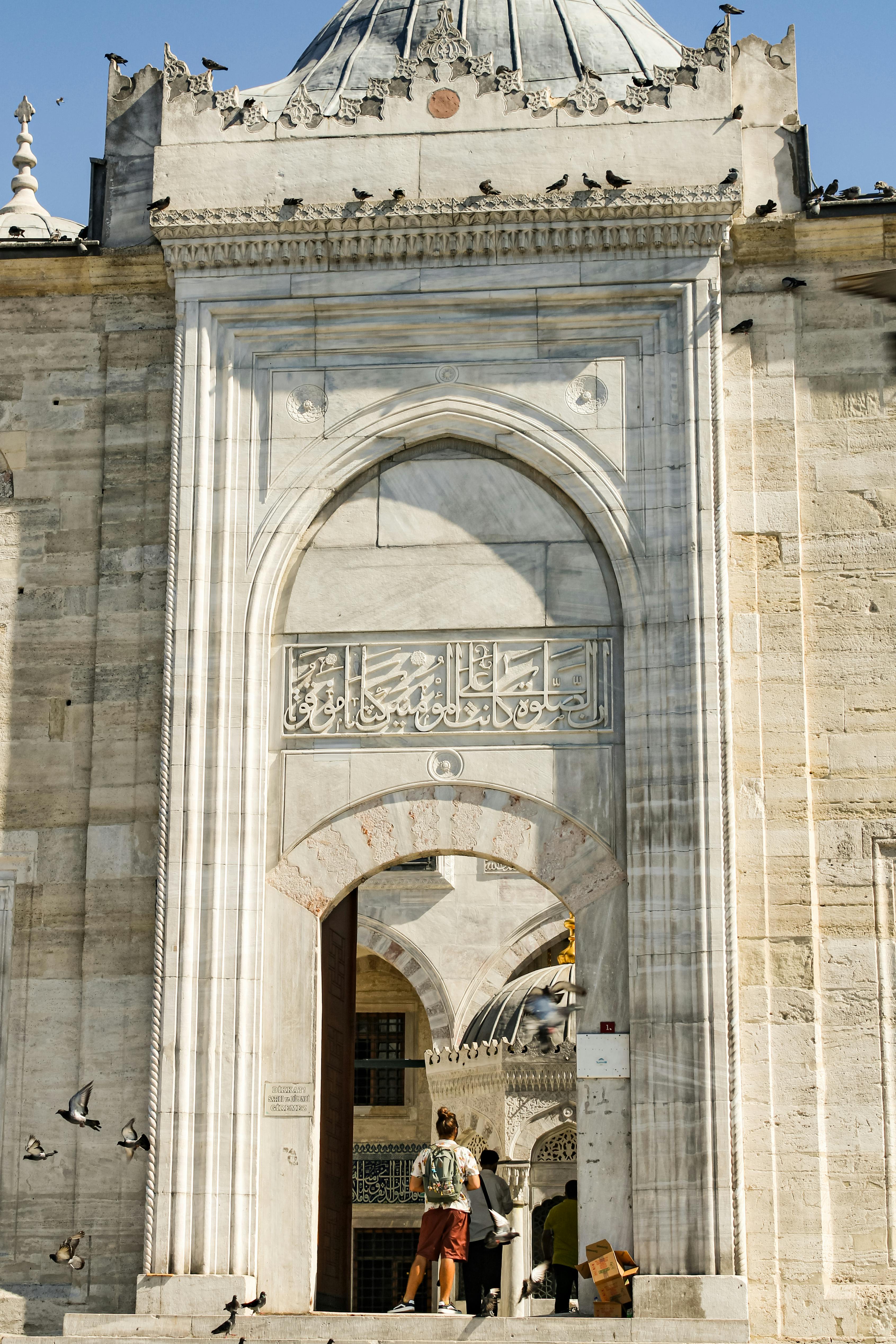 Tourist Standing in Mosque Entrance Gate · Free Stock Photo