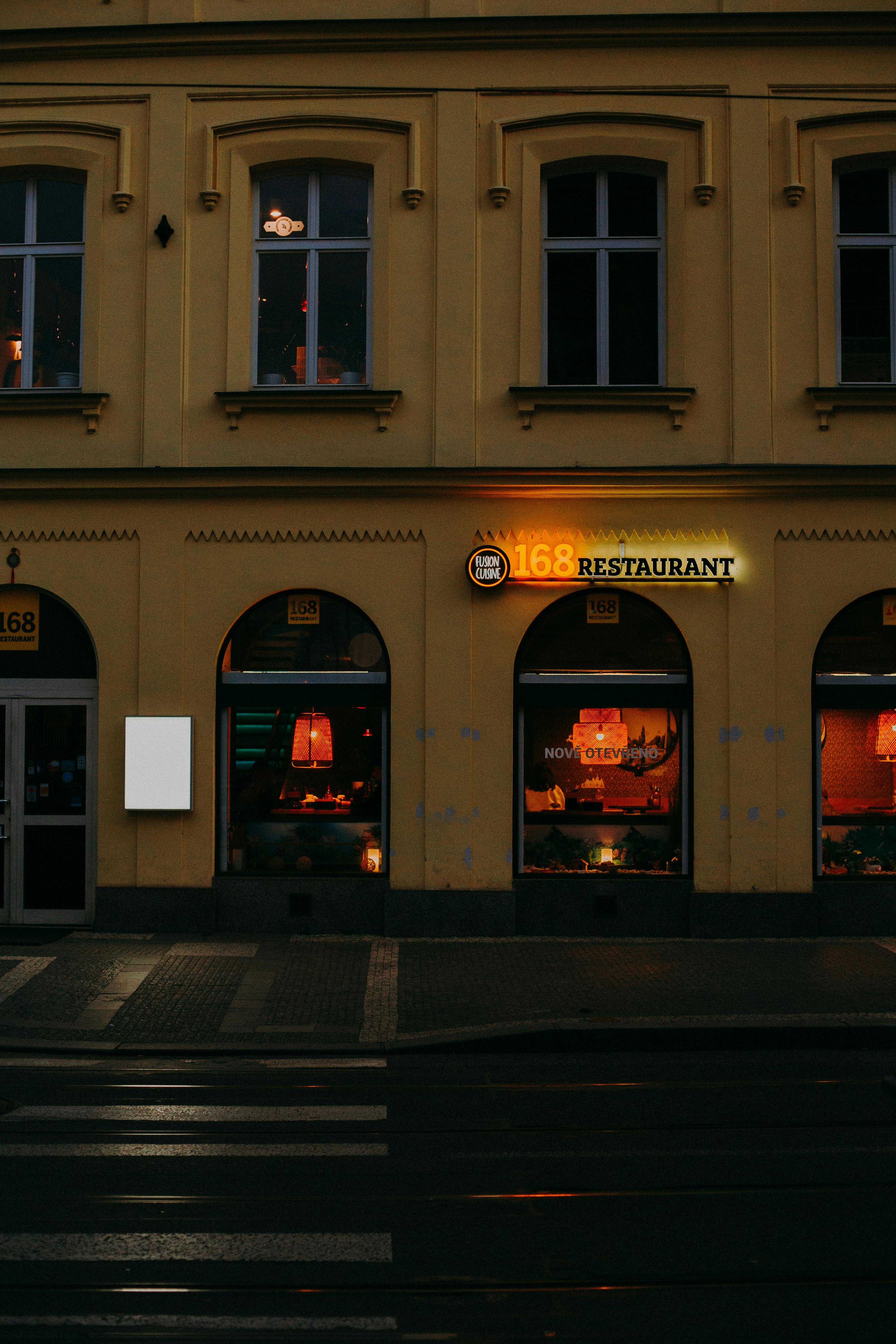 A yellow building with a sign that says, the restaurant · Free Stock Photo