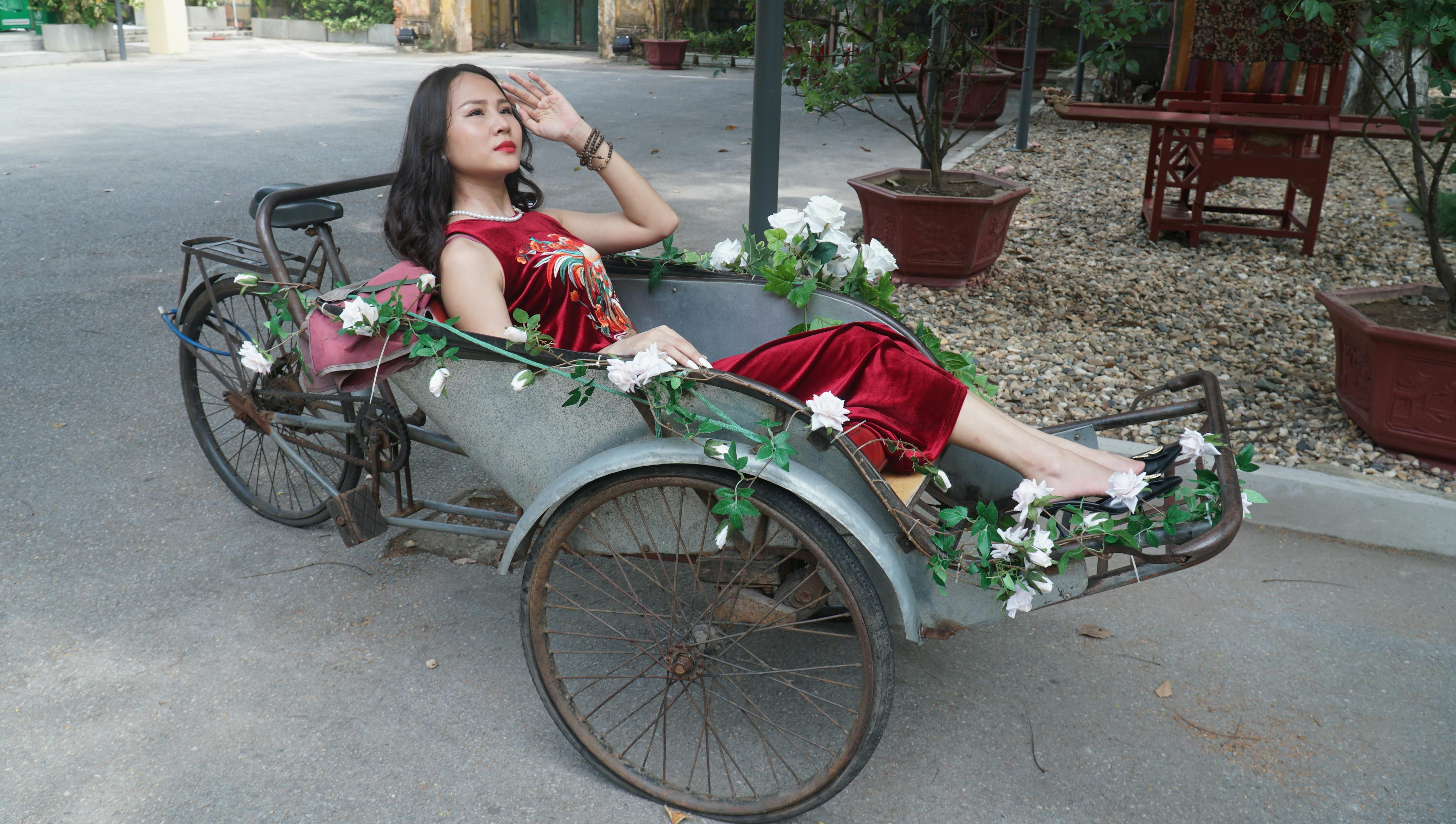 Woman Lying Down and Posing on Tricycle · Free Stock Photo