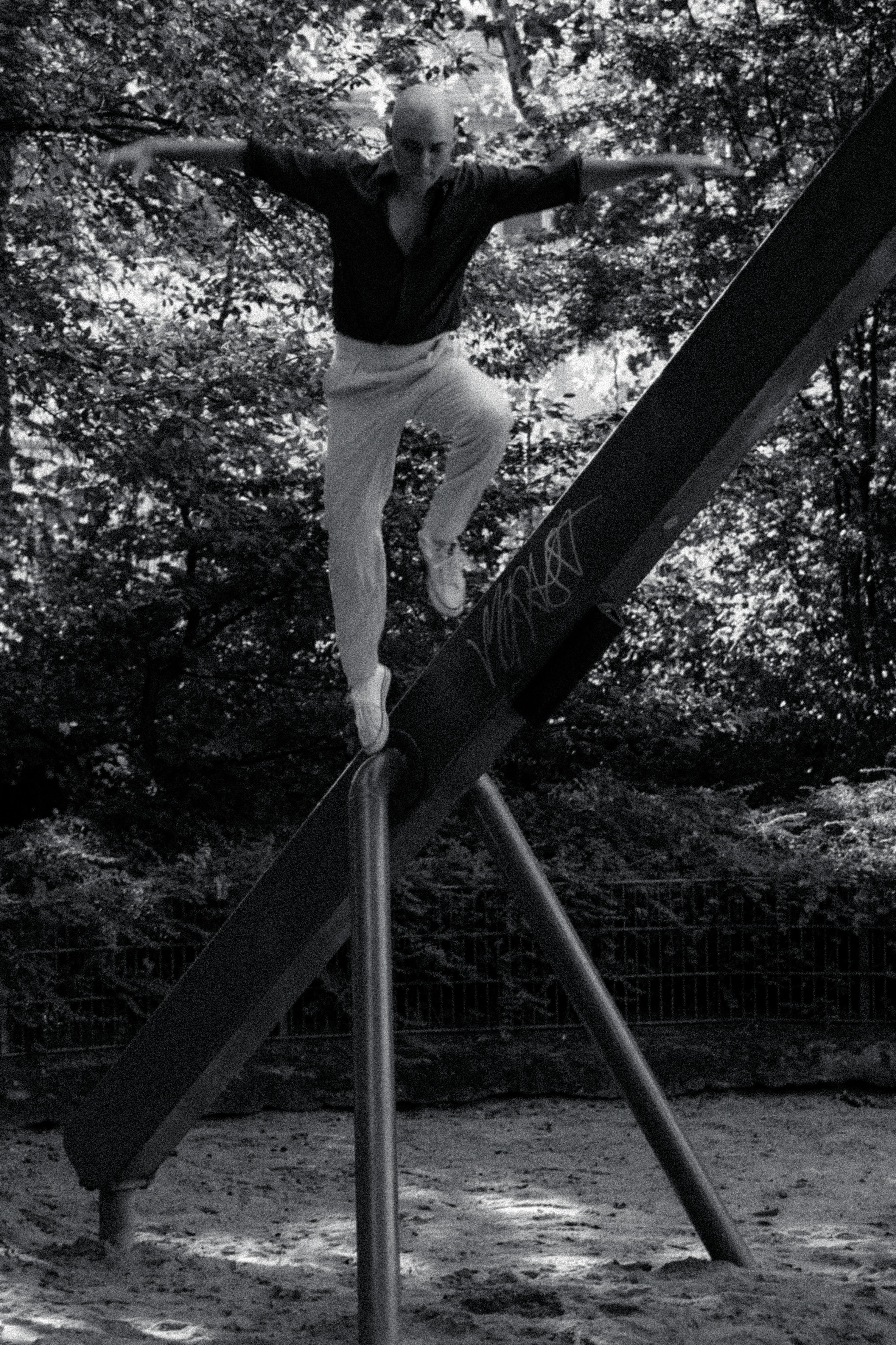 Man Balancing on Metal Support · Free Stock Photo