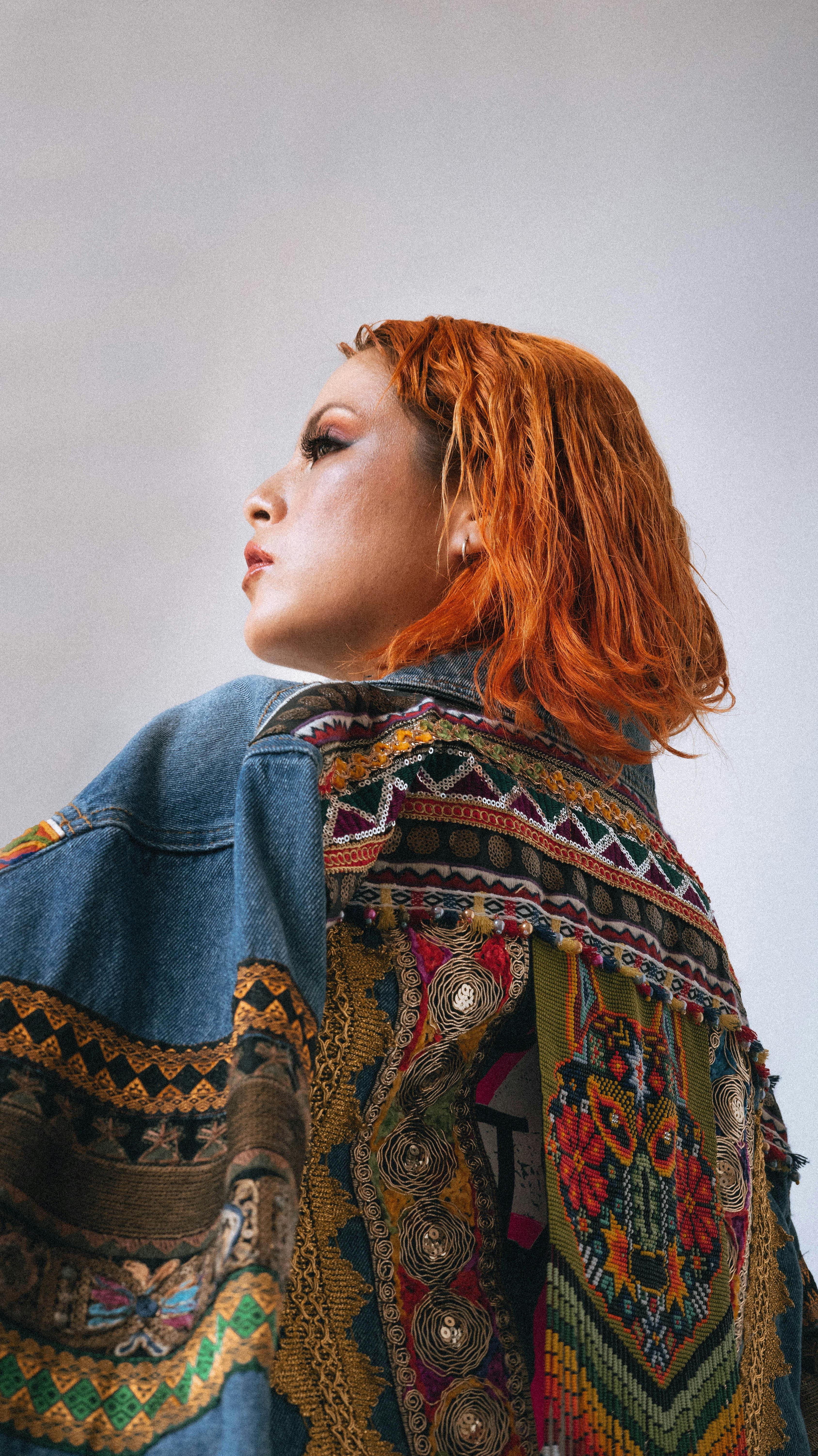 Red Haired Woman in Denim Jacket with Aztec Embroidery · Free Stock Photo