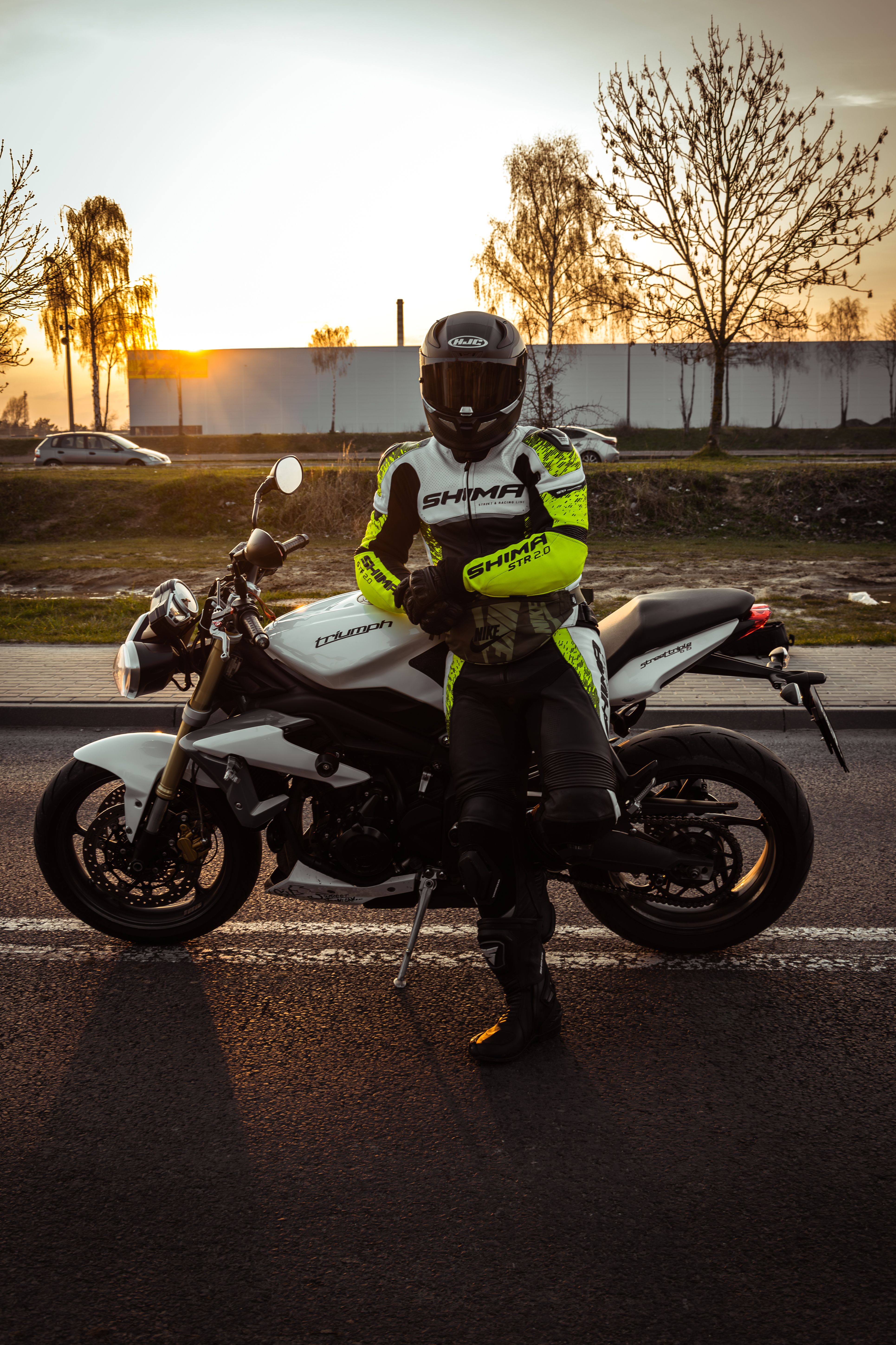 Motorcyclist with Helmet in Uniform Standing by White Motorcycle · Free ...