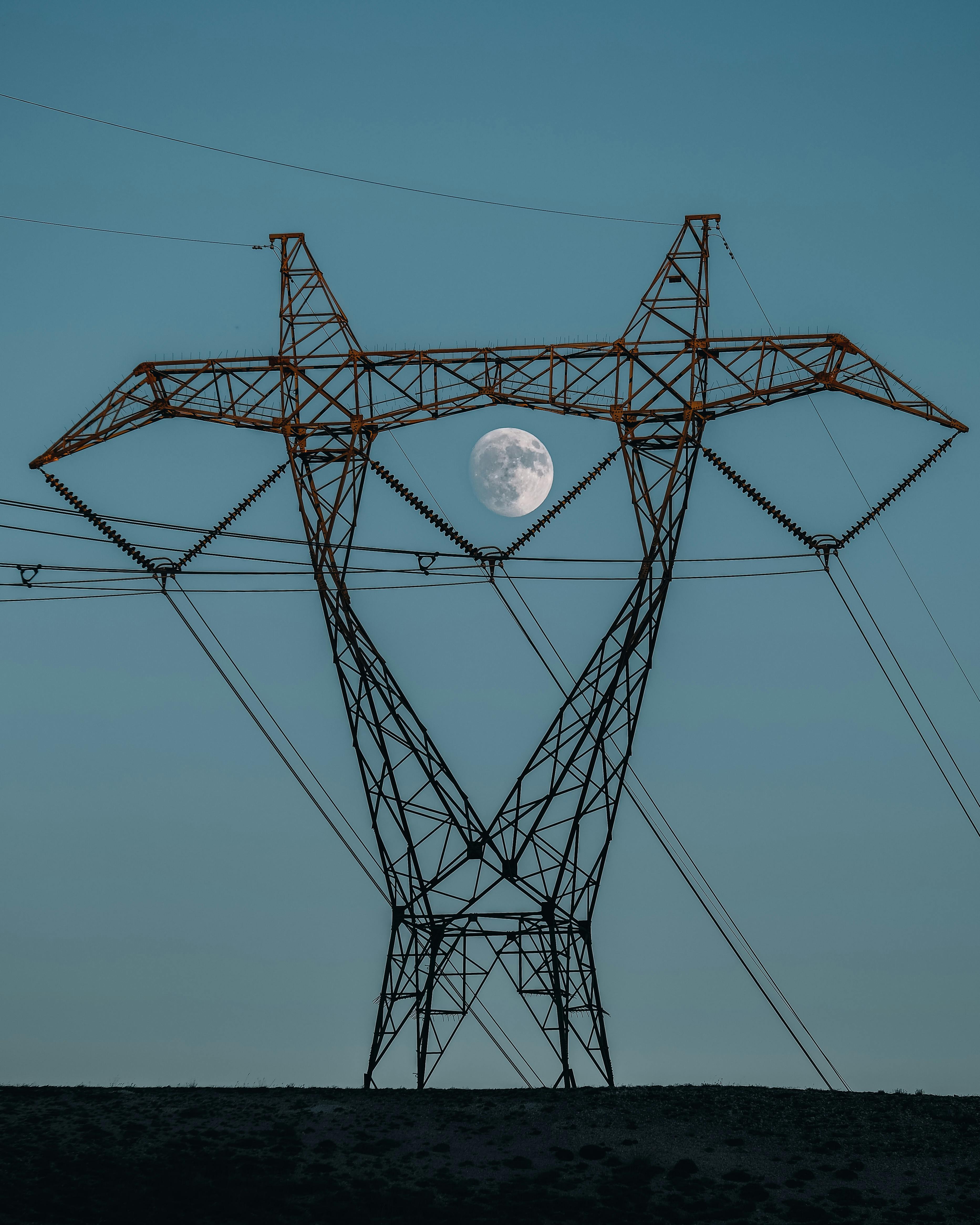 Moon behind Transmission Tower · Free Stock Photo