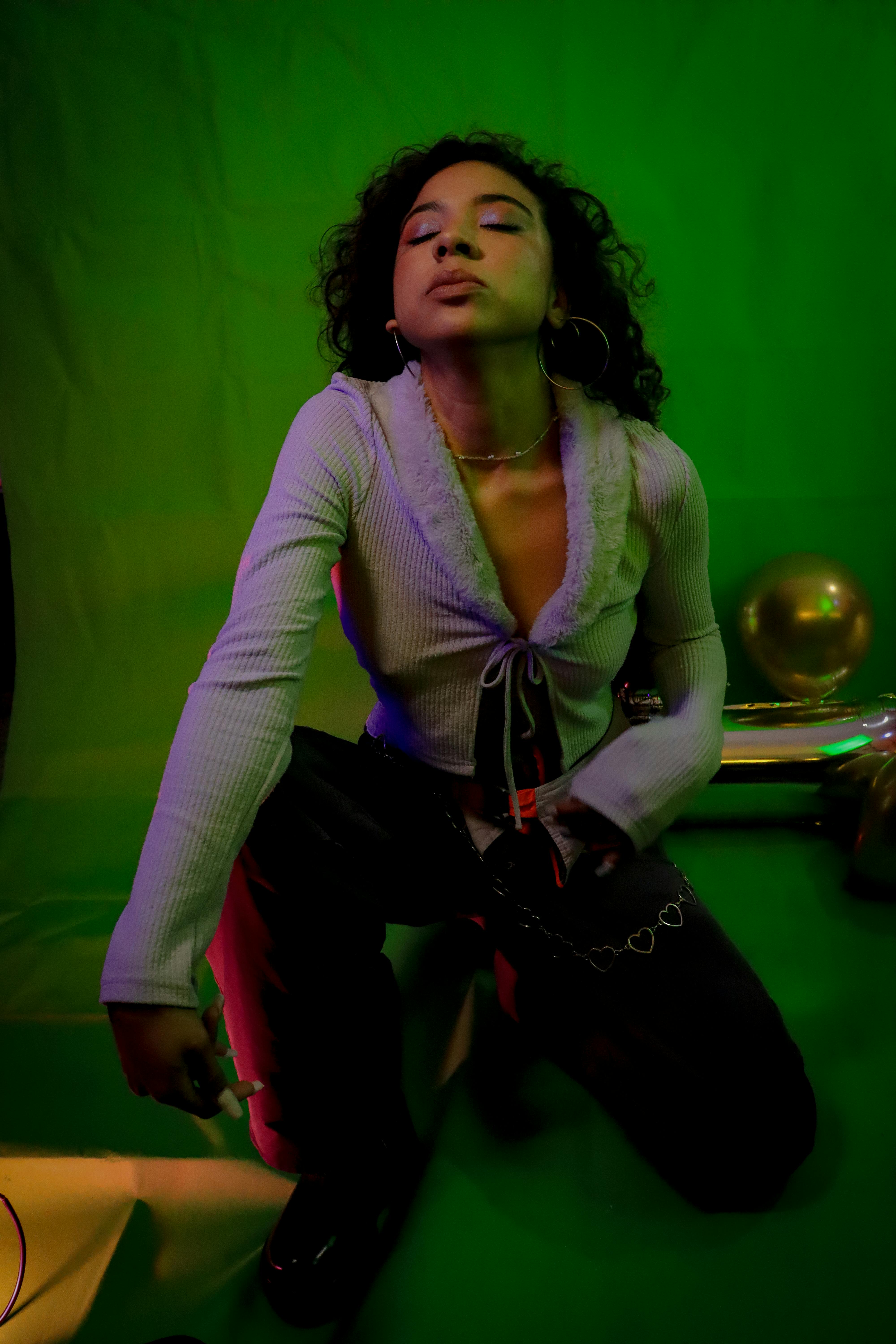 Female Fashion Model Crouching Against a White Background · Free Stock ...