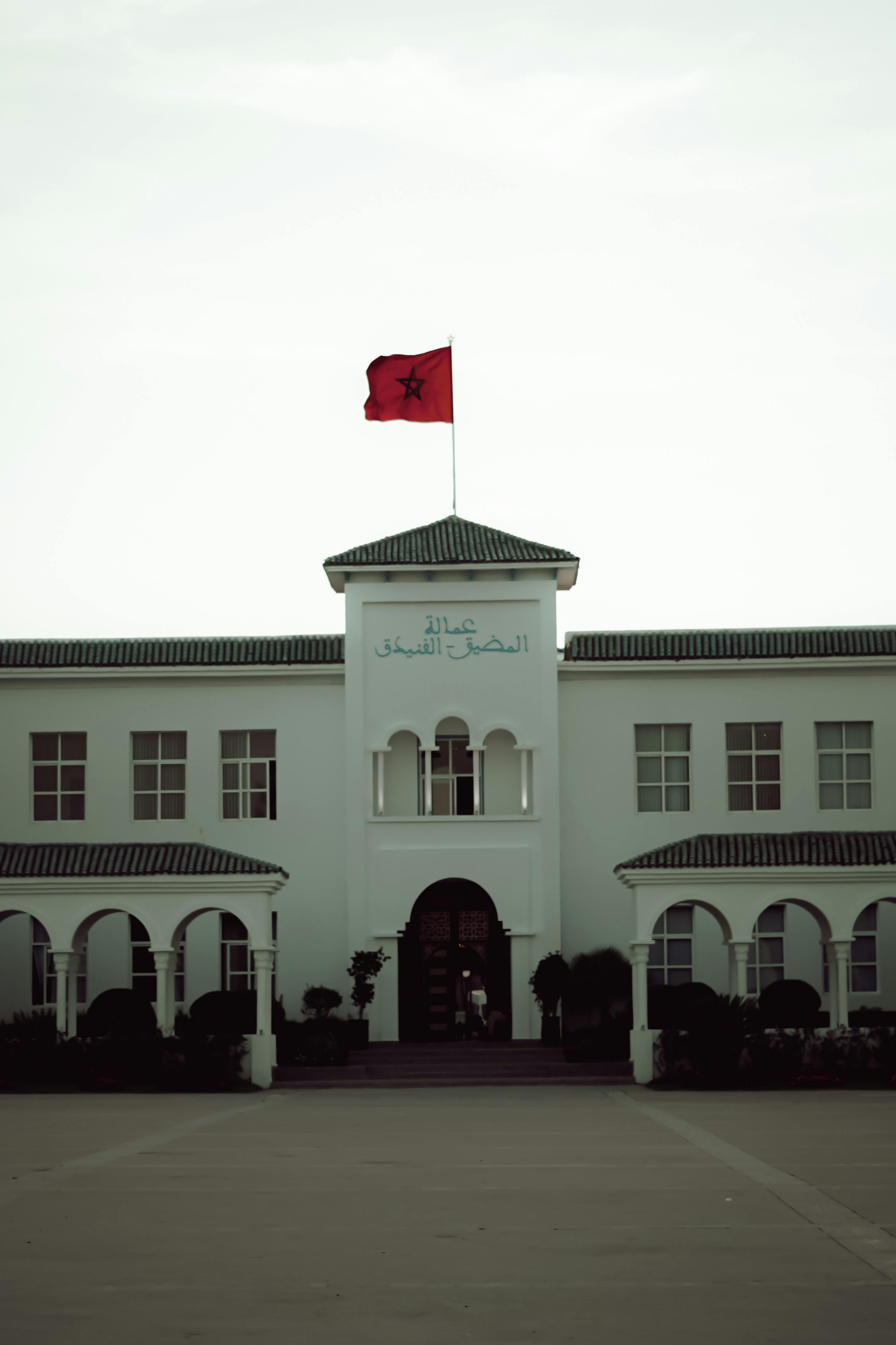 White Building with the Moroccan Flag · Free Stock Photo