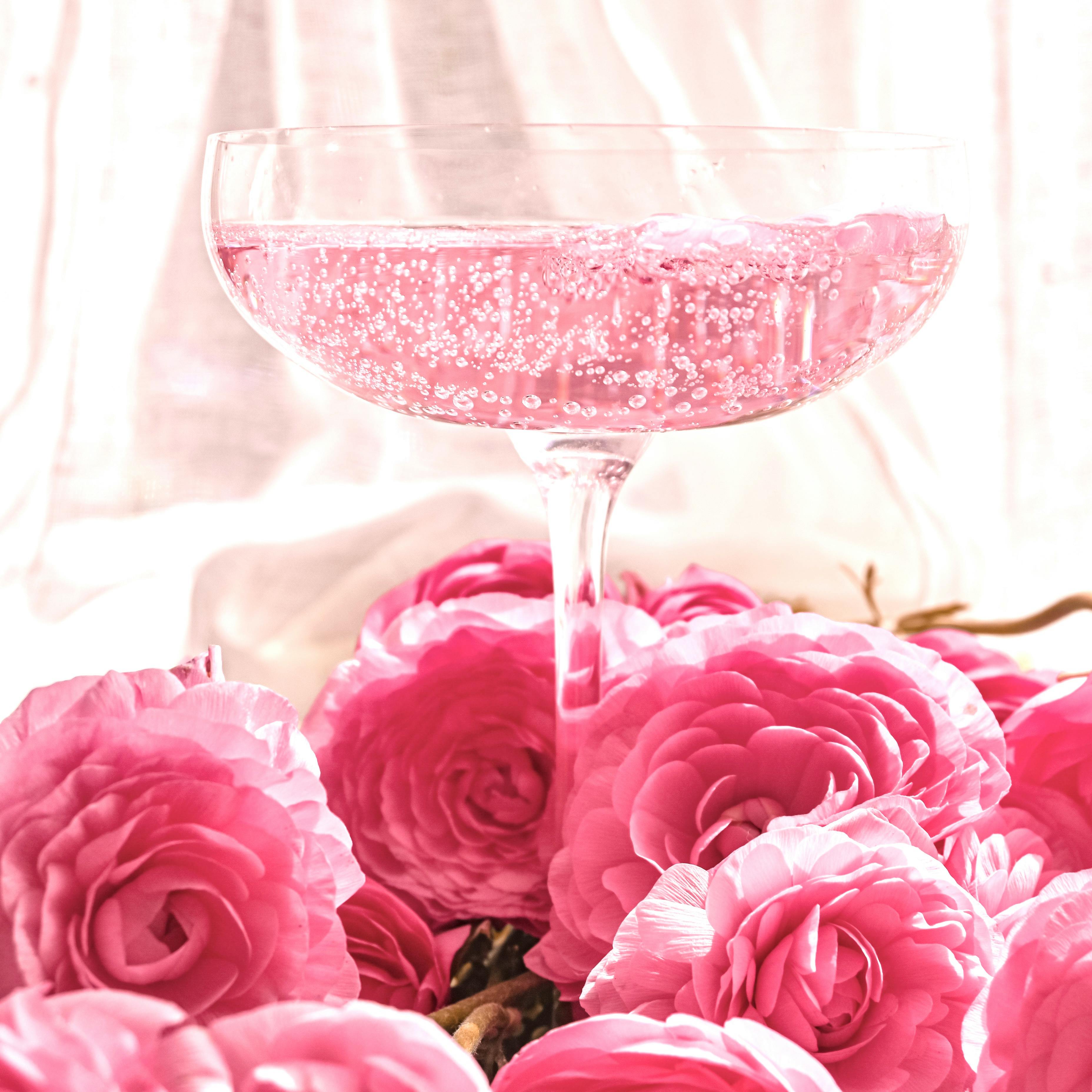 A Bunch of Pink Roses and a Glass with Drink · Free Stock Photo