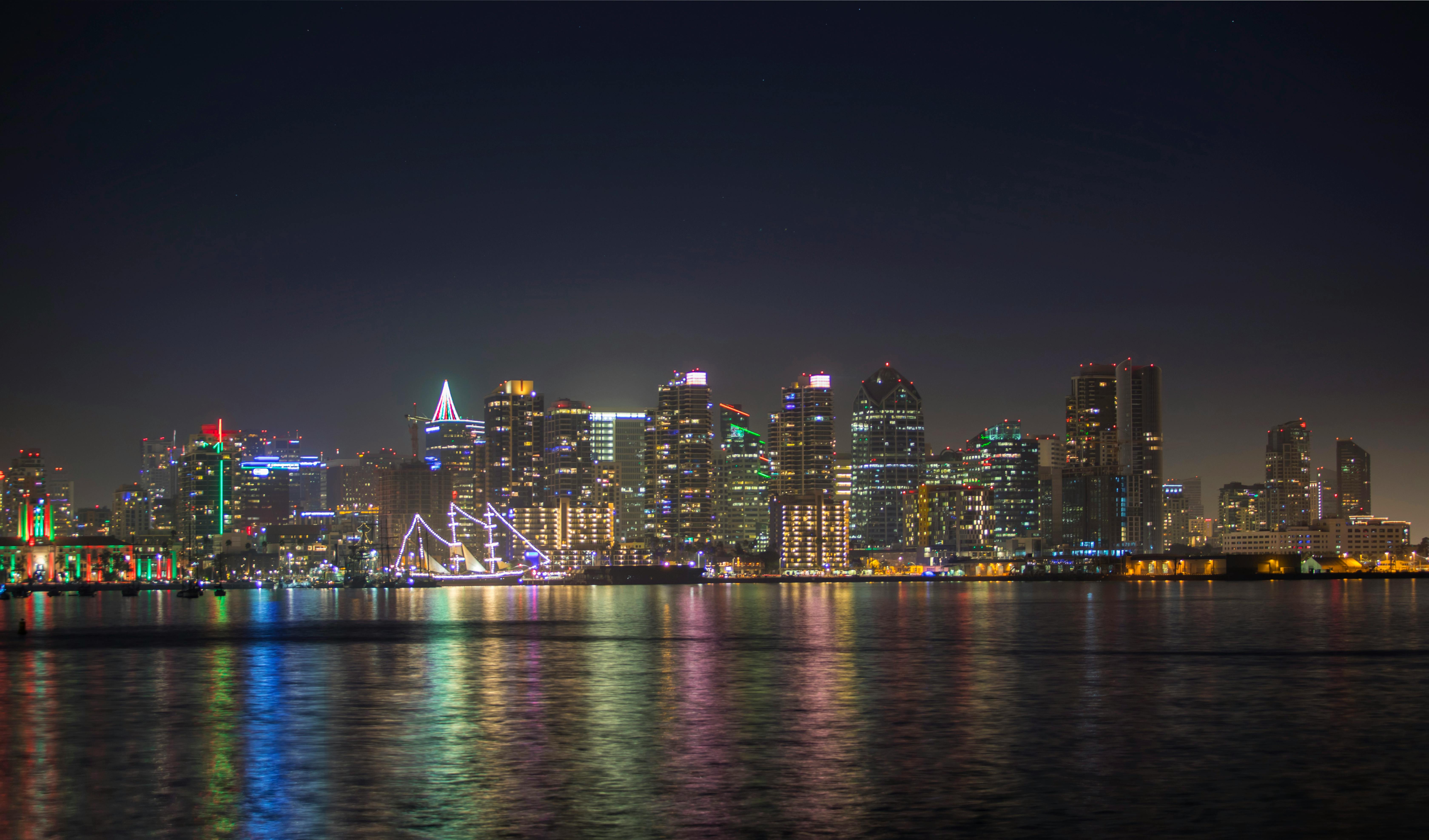 Illuminated City on Sea Coast at Night · Free Stock Photo
