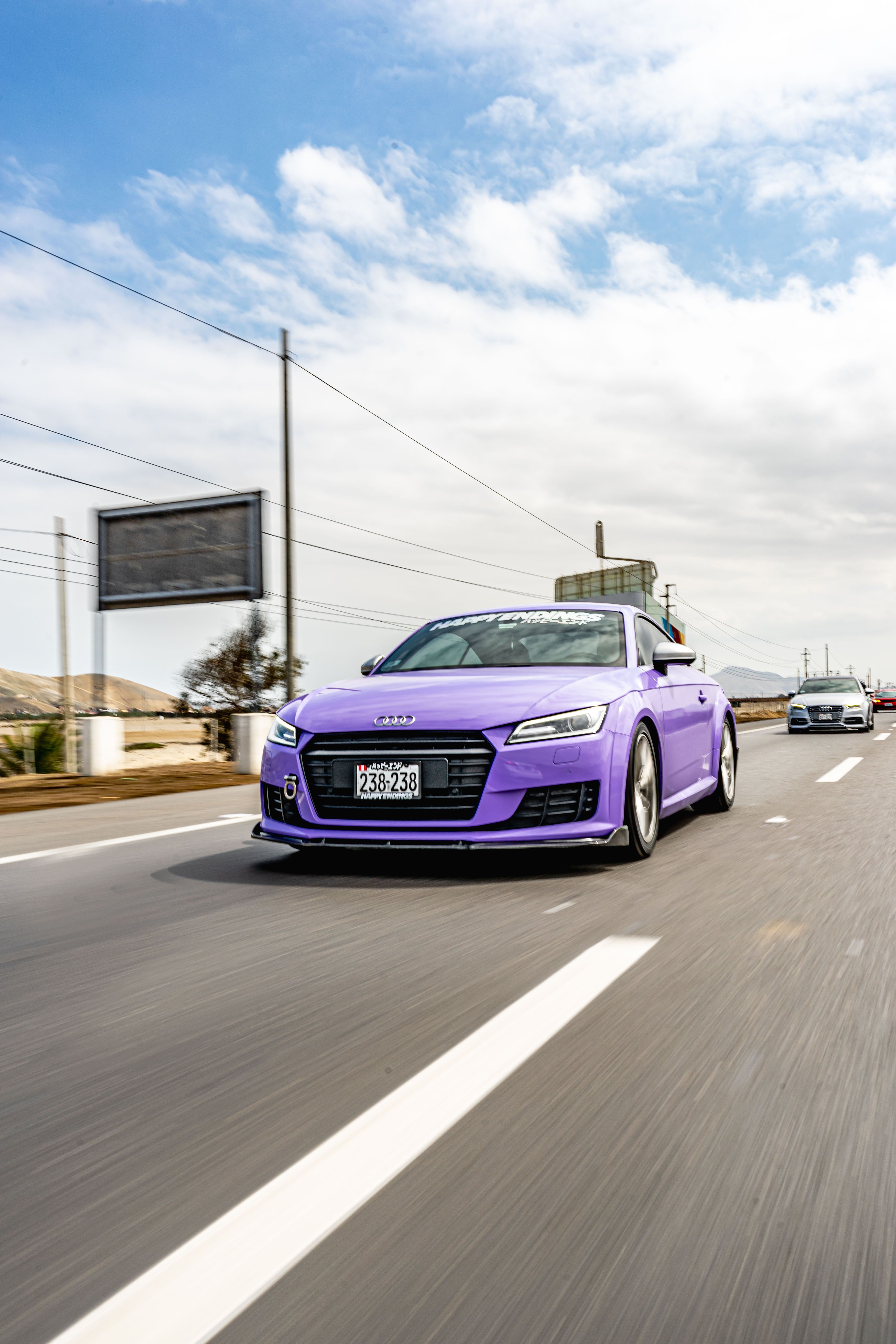 Purple Car Driving Down the Road · Free Stock Photo