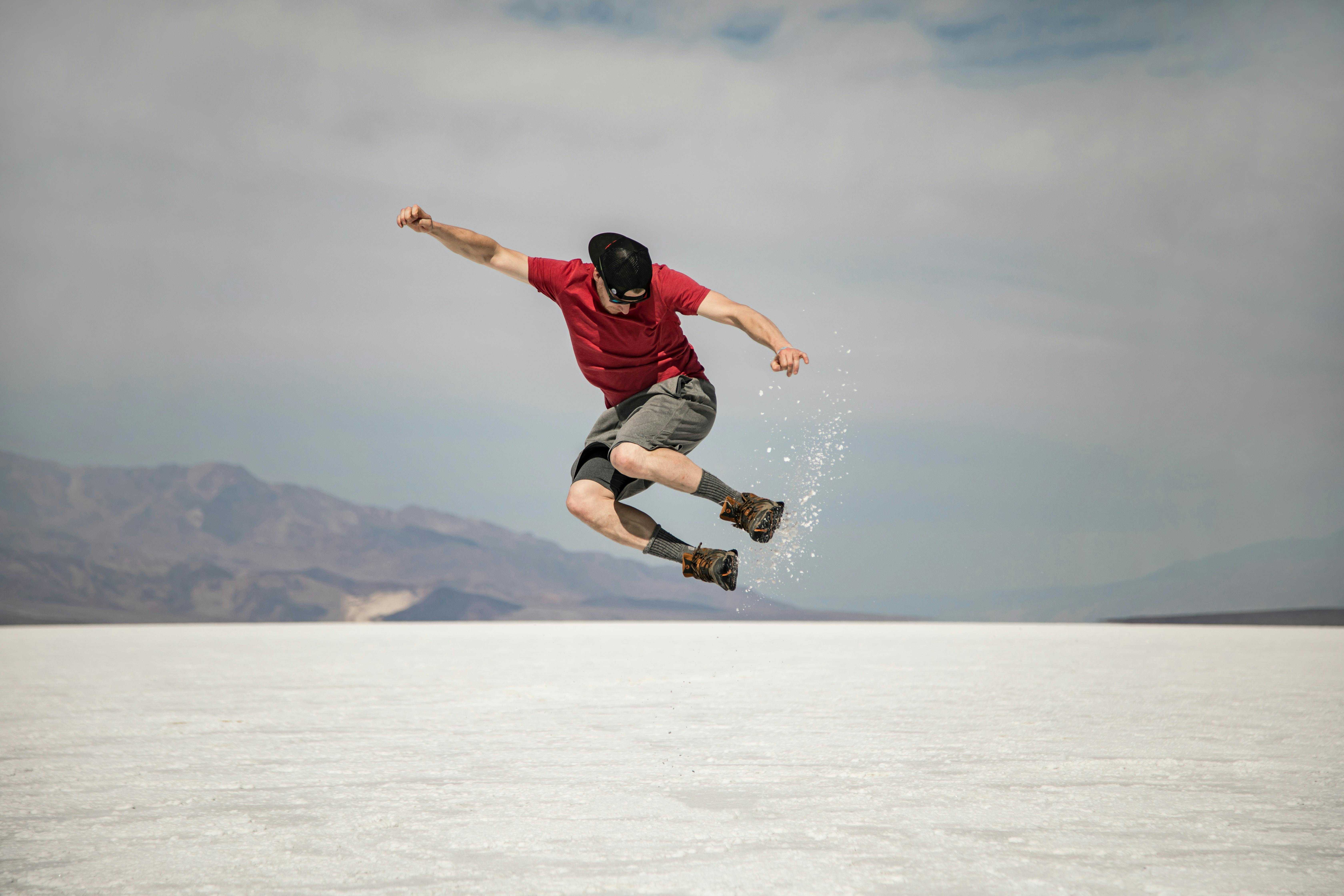 A Man wearing Cap Jumping on the Barrier · Free Stock Photo