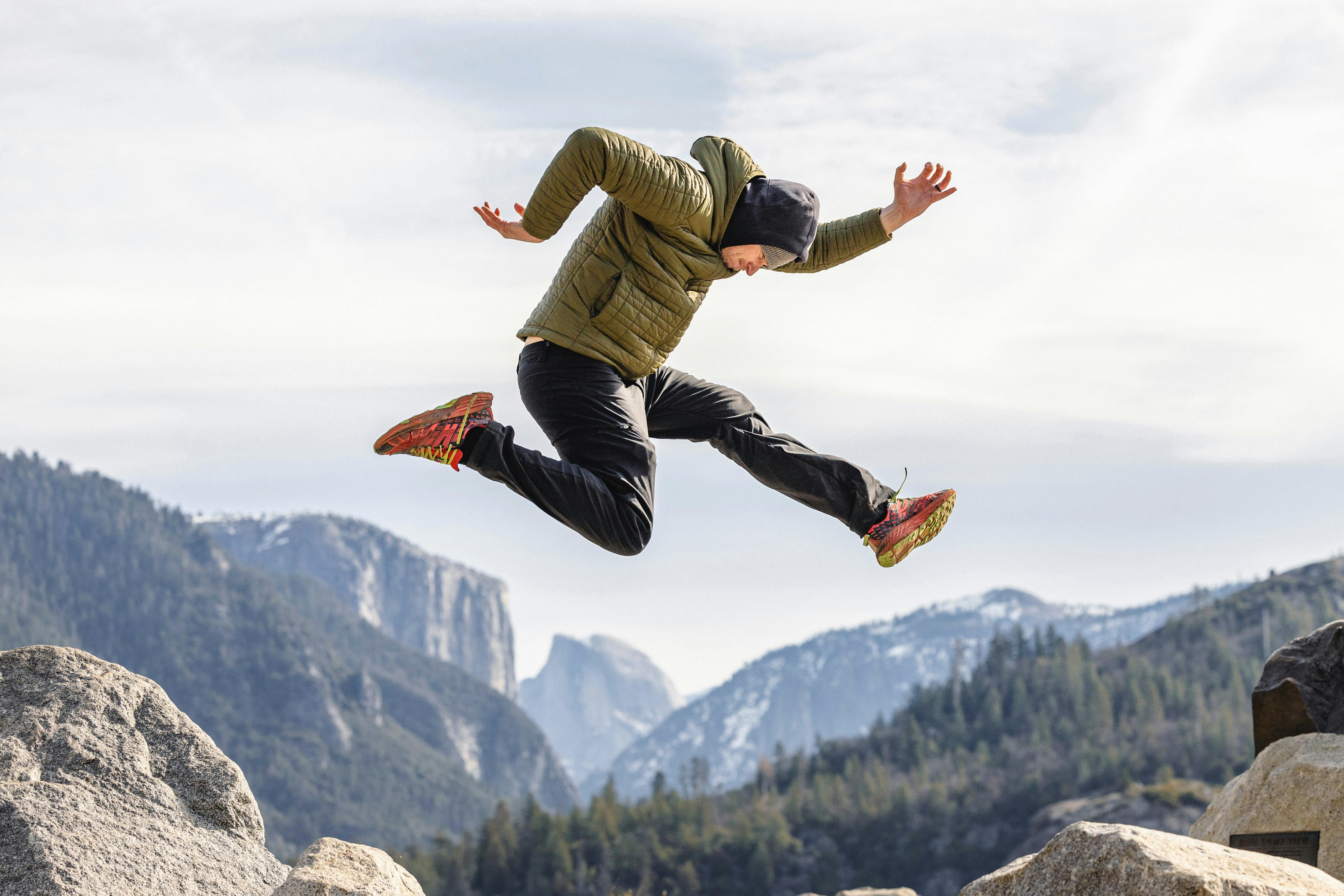Man Jumping over the Rocks in Mountains · Free Stock Photo