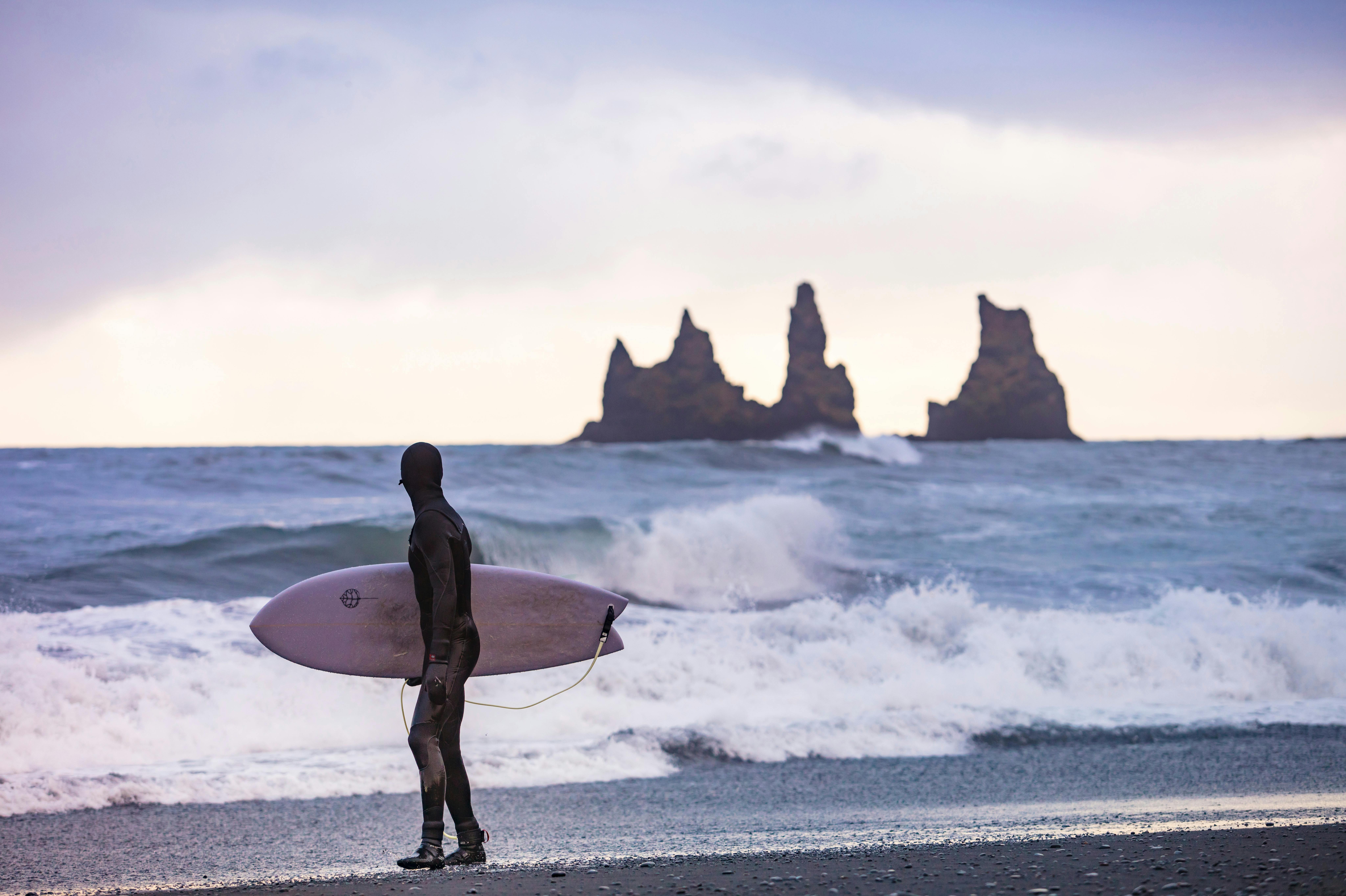Man with Surfboard at Beach · Free Stock Photo