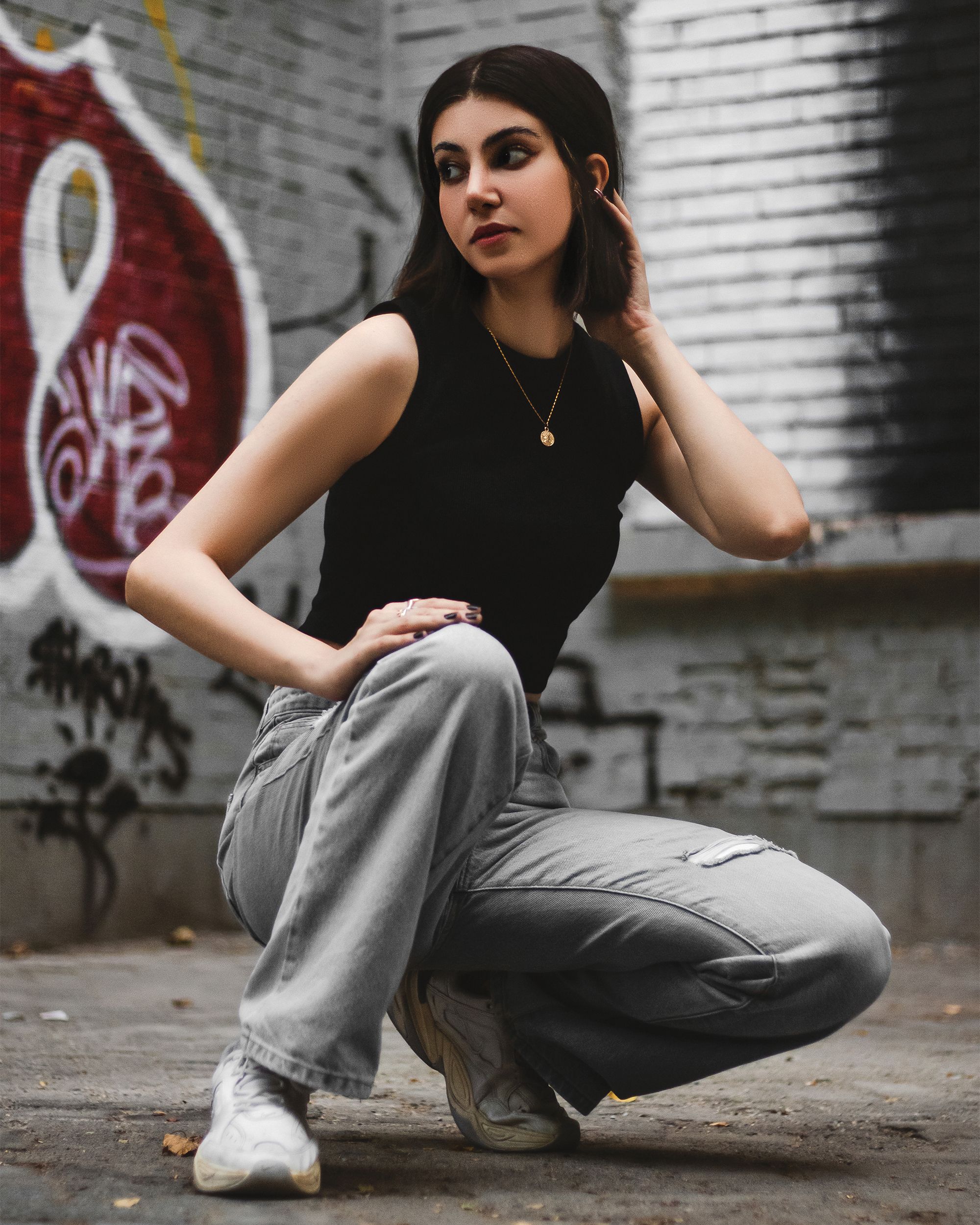 Woman Squatting and Posing · Free Stock Photo