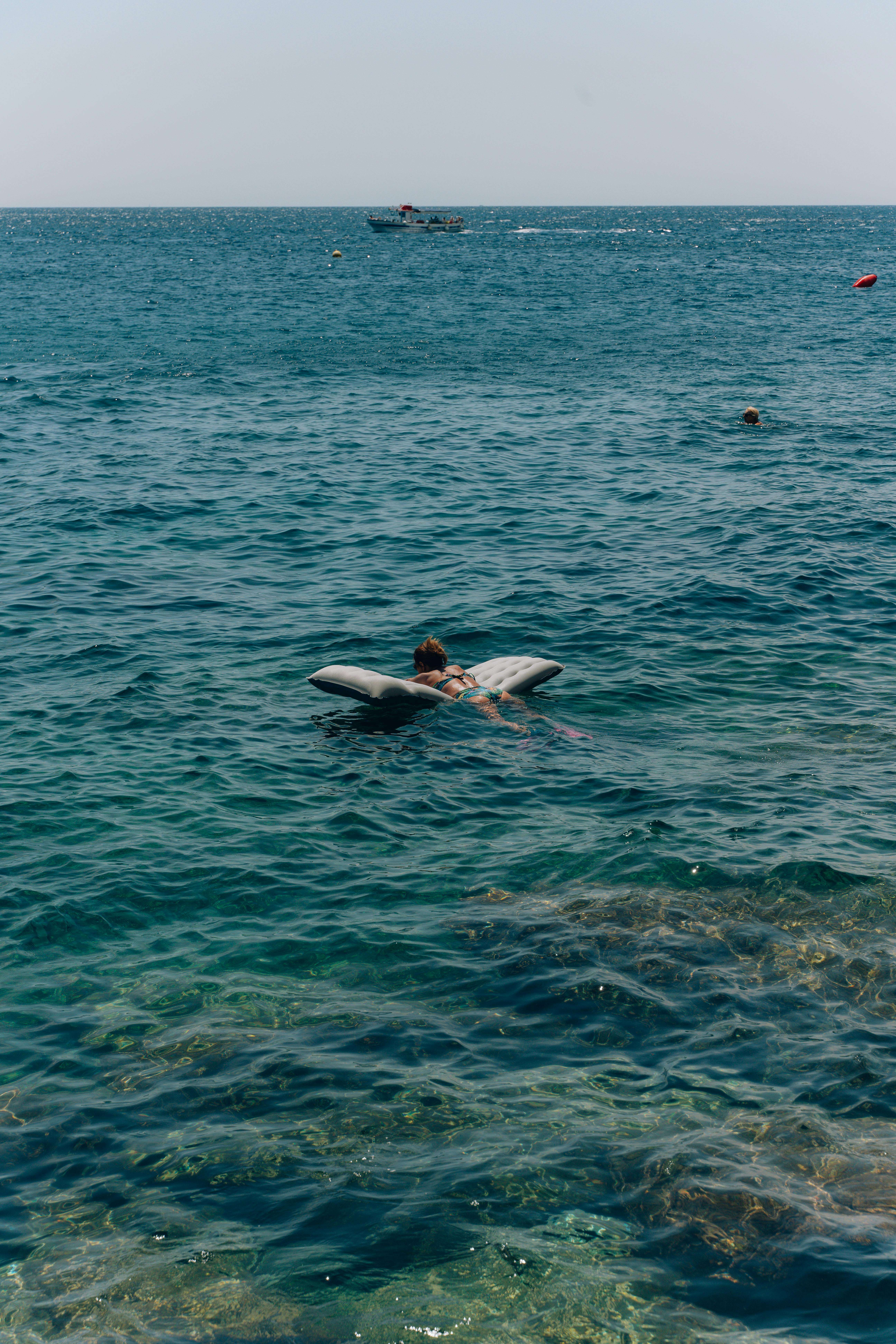 Woman Floating on Air Mattress on Seashore · Free Stock Photo
