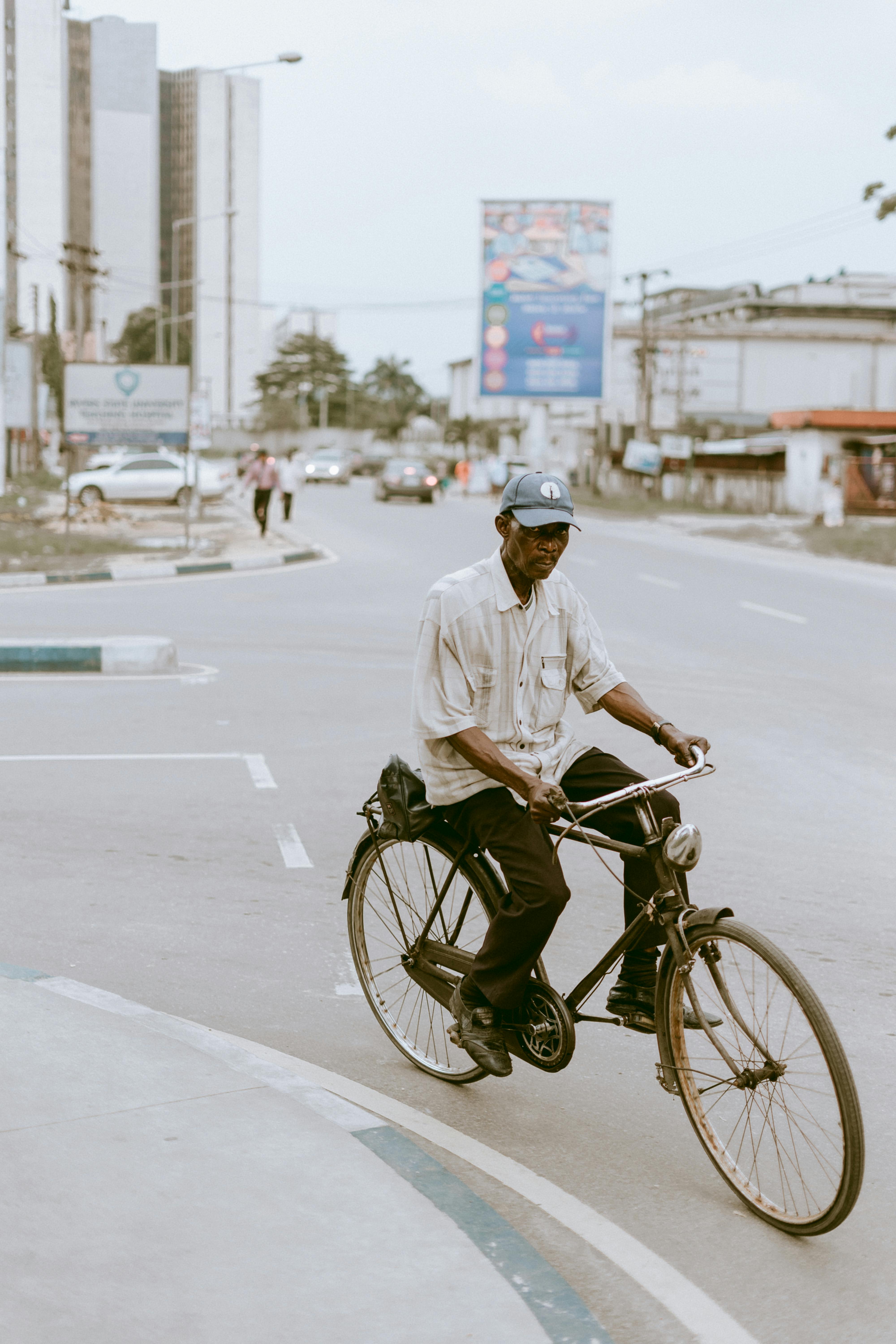Man Riding Bike in City · Free Stock Photo