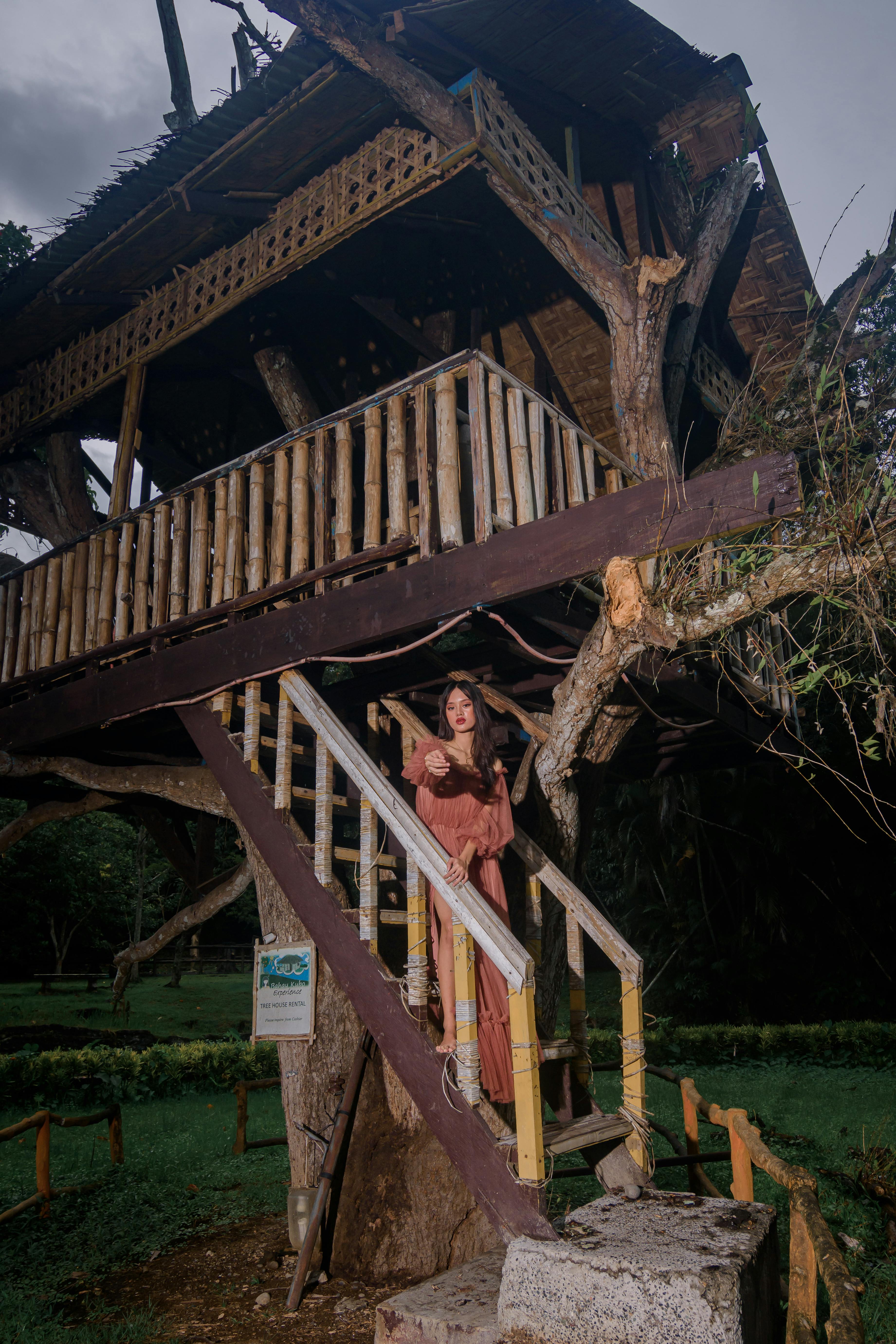Woman Standing on Staircase of Tree House · Free Stock Photo