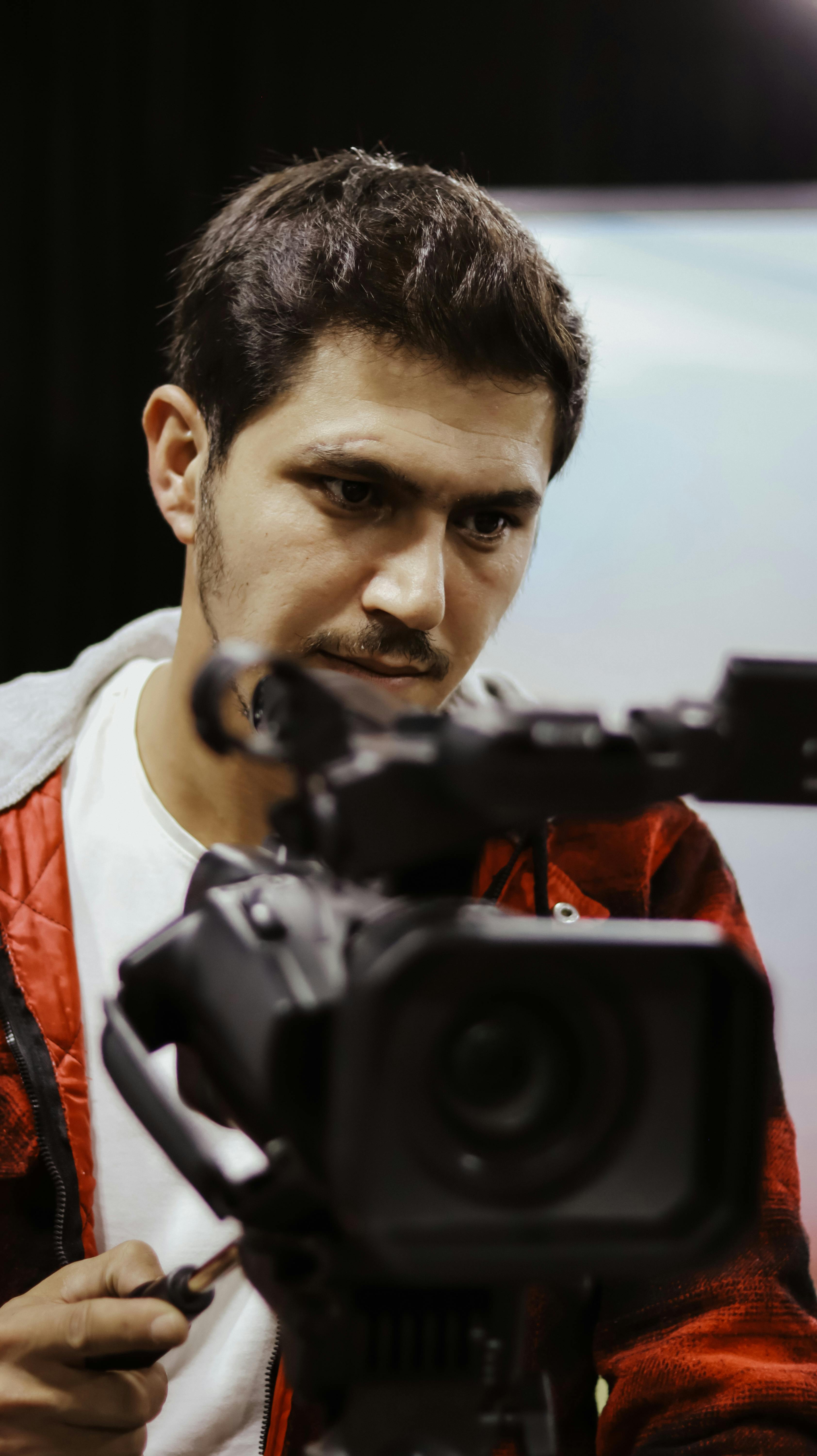 Man Sitting and Holding Vintage Camera · Free Stock Photo