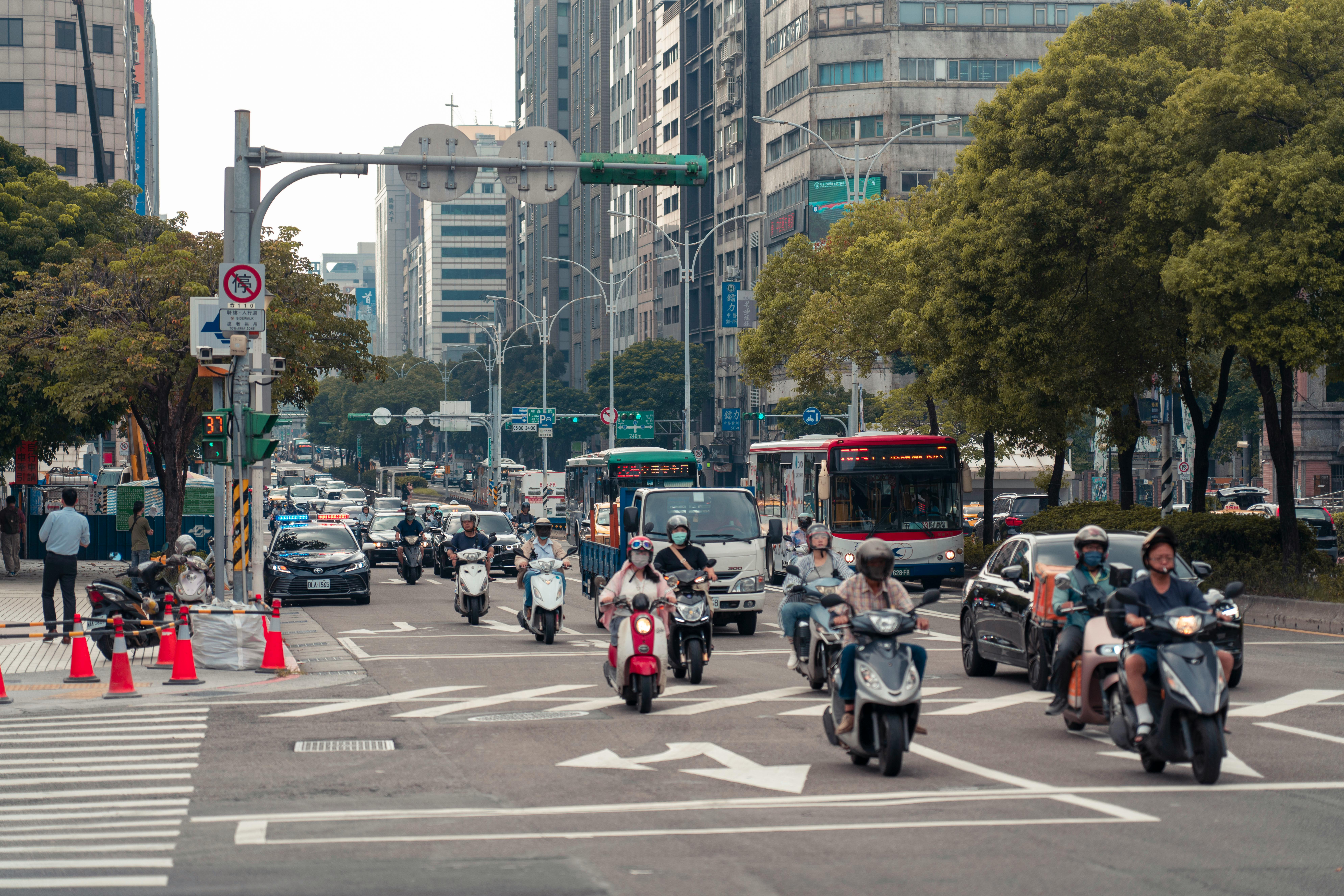 People Riding on Scooters in a City Center · Free Stock Photo