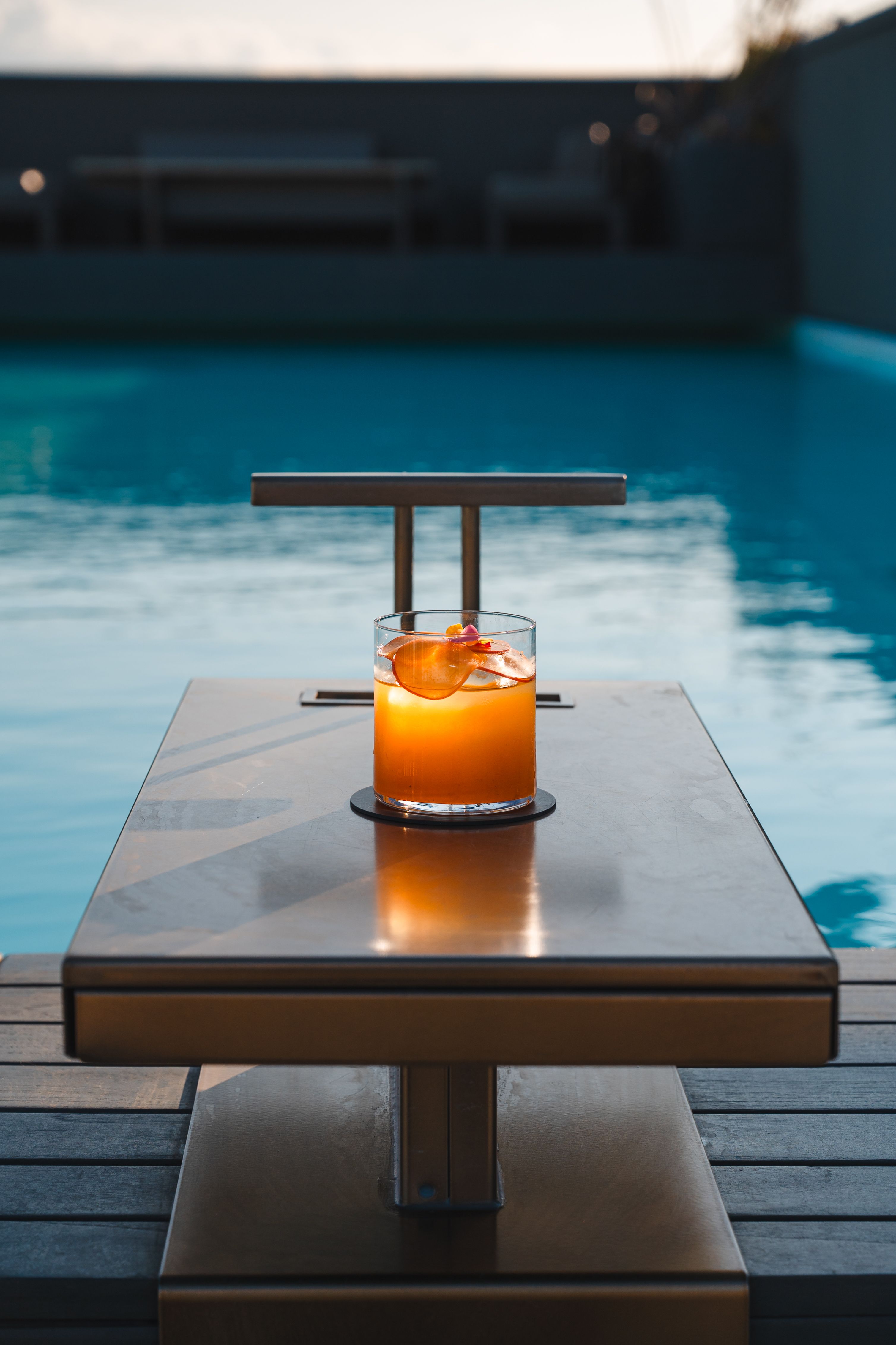 Glass of Cocktail on a Table by the Pool · Free Stock Photo