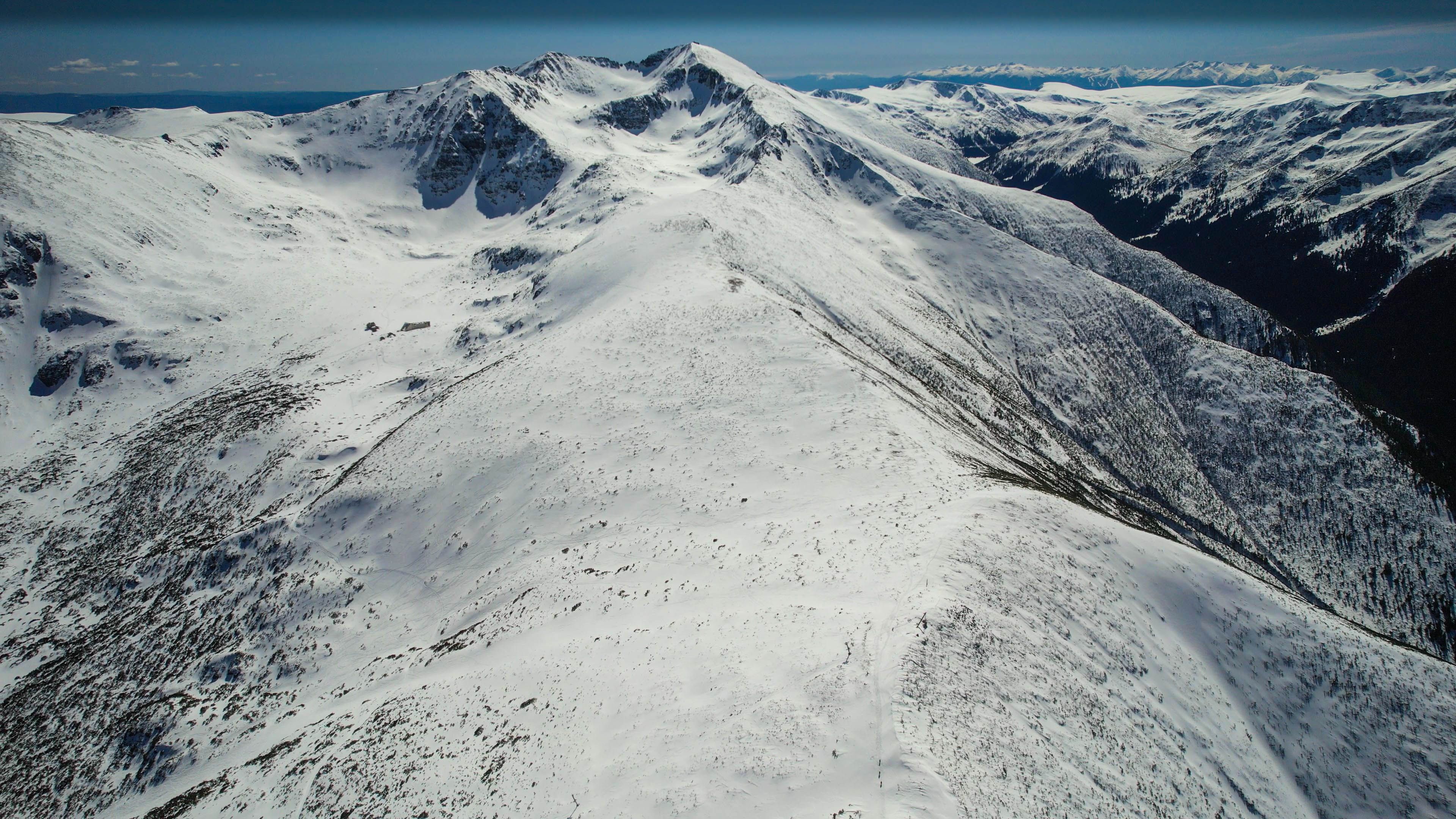Aerial Photography Of Snowy Hill · Free Stock Photo