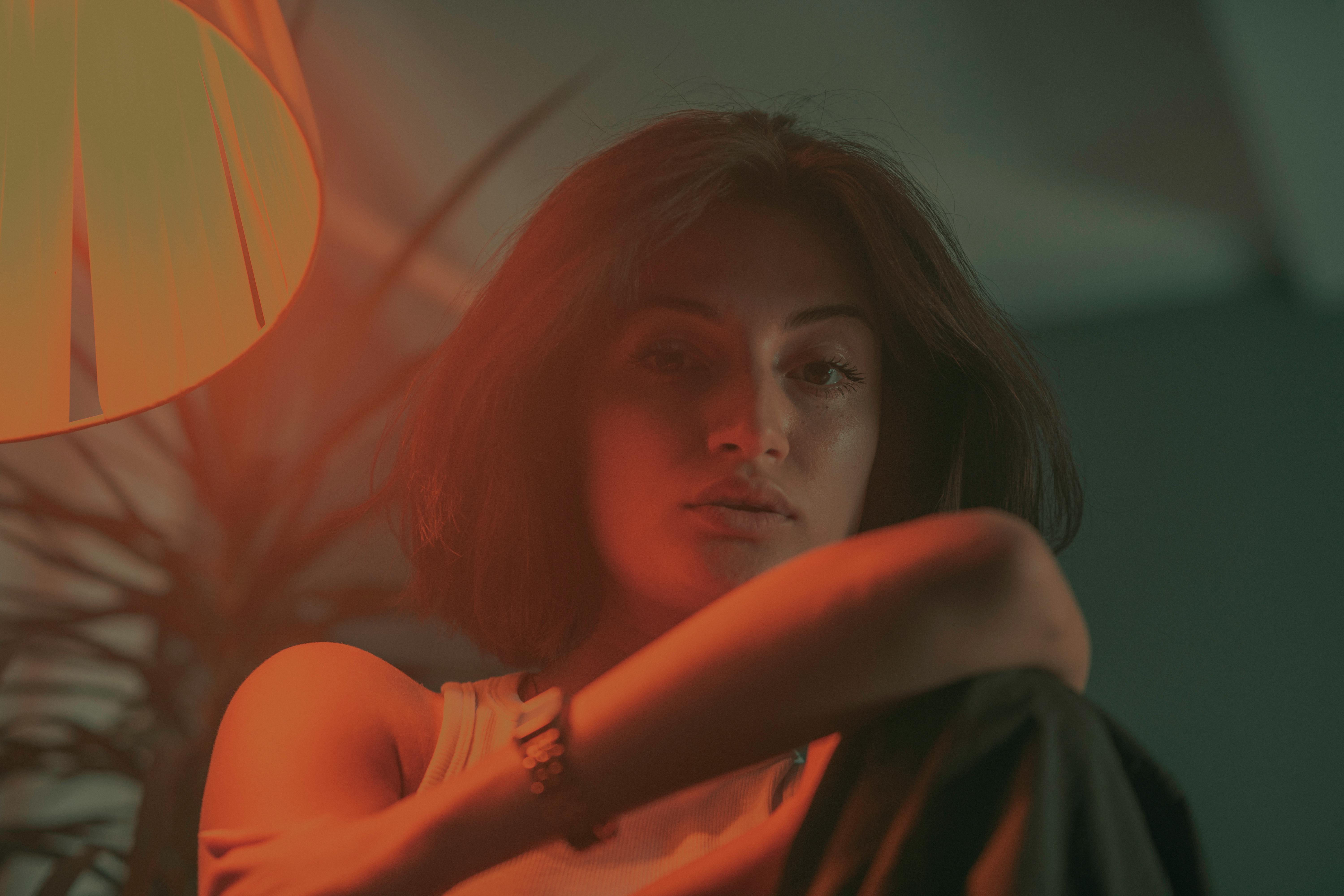 Woman Sitting at the Table In Dim Light · Free Stock Photo