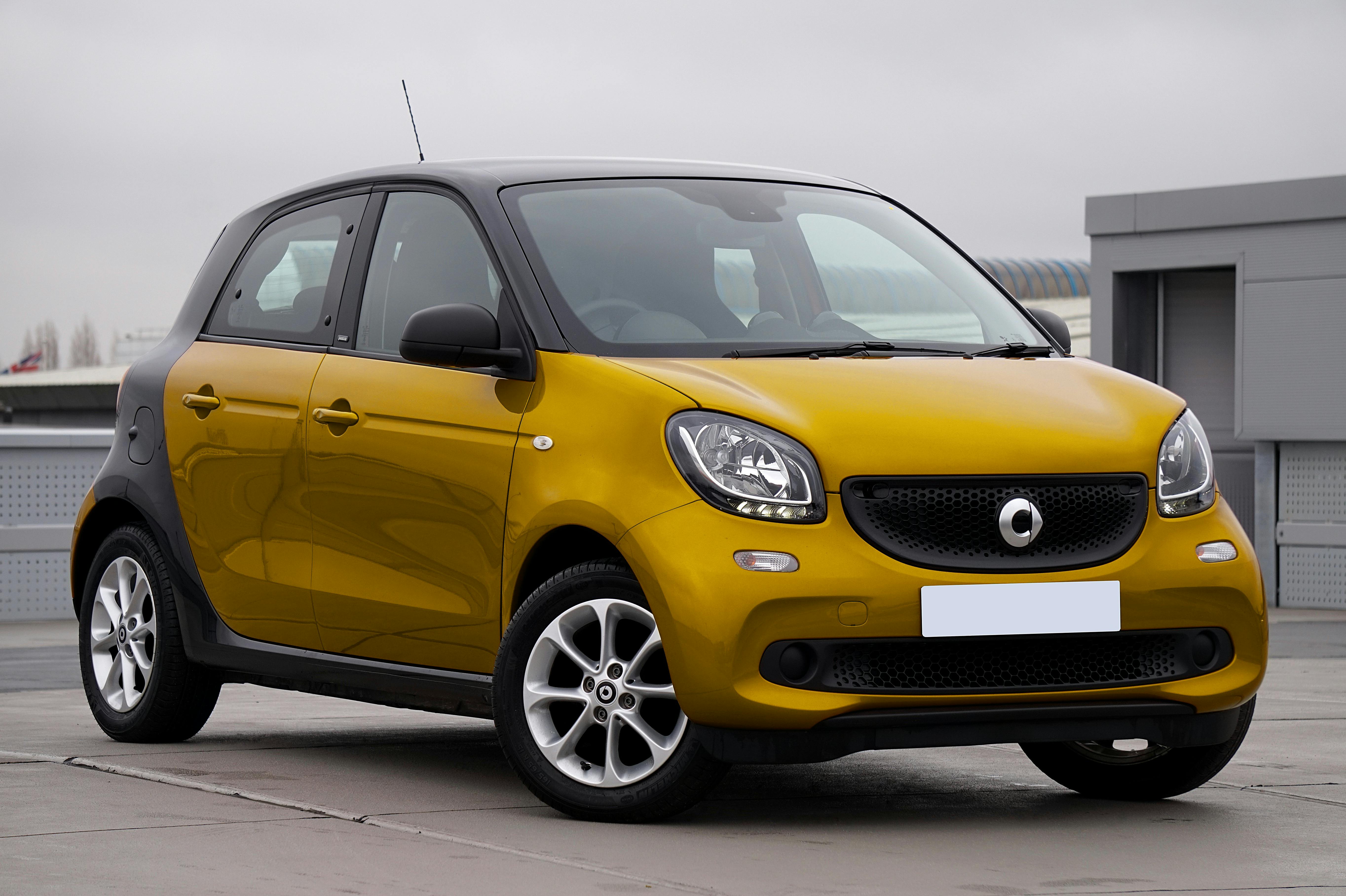 A Yellow Smart Forfour on a Parking Lot · Free Stock Photo