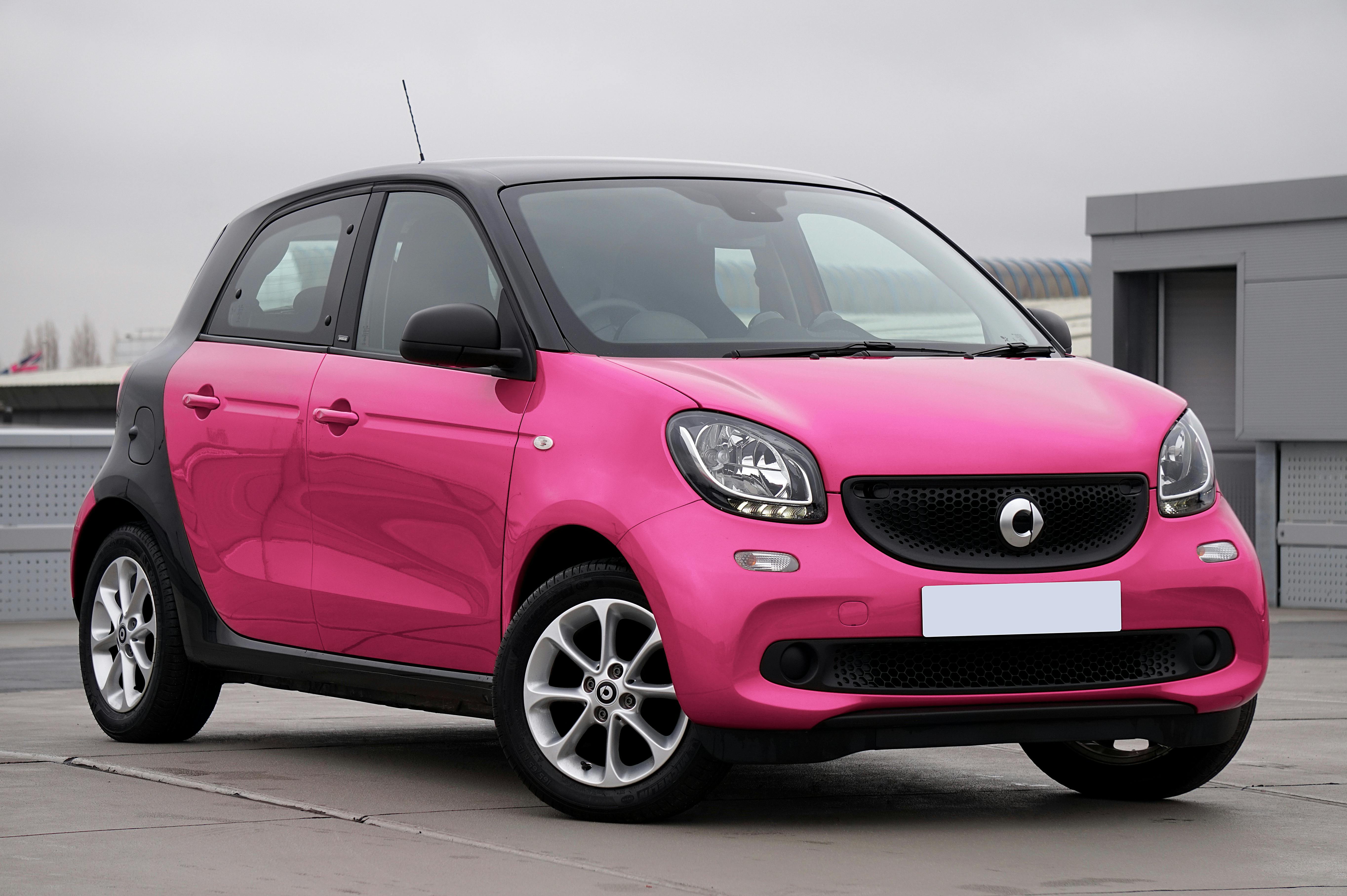 View of a Modern Pink Smart Forfour on a Parking Lot · Free Stock Photo