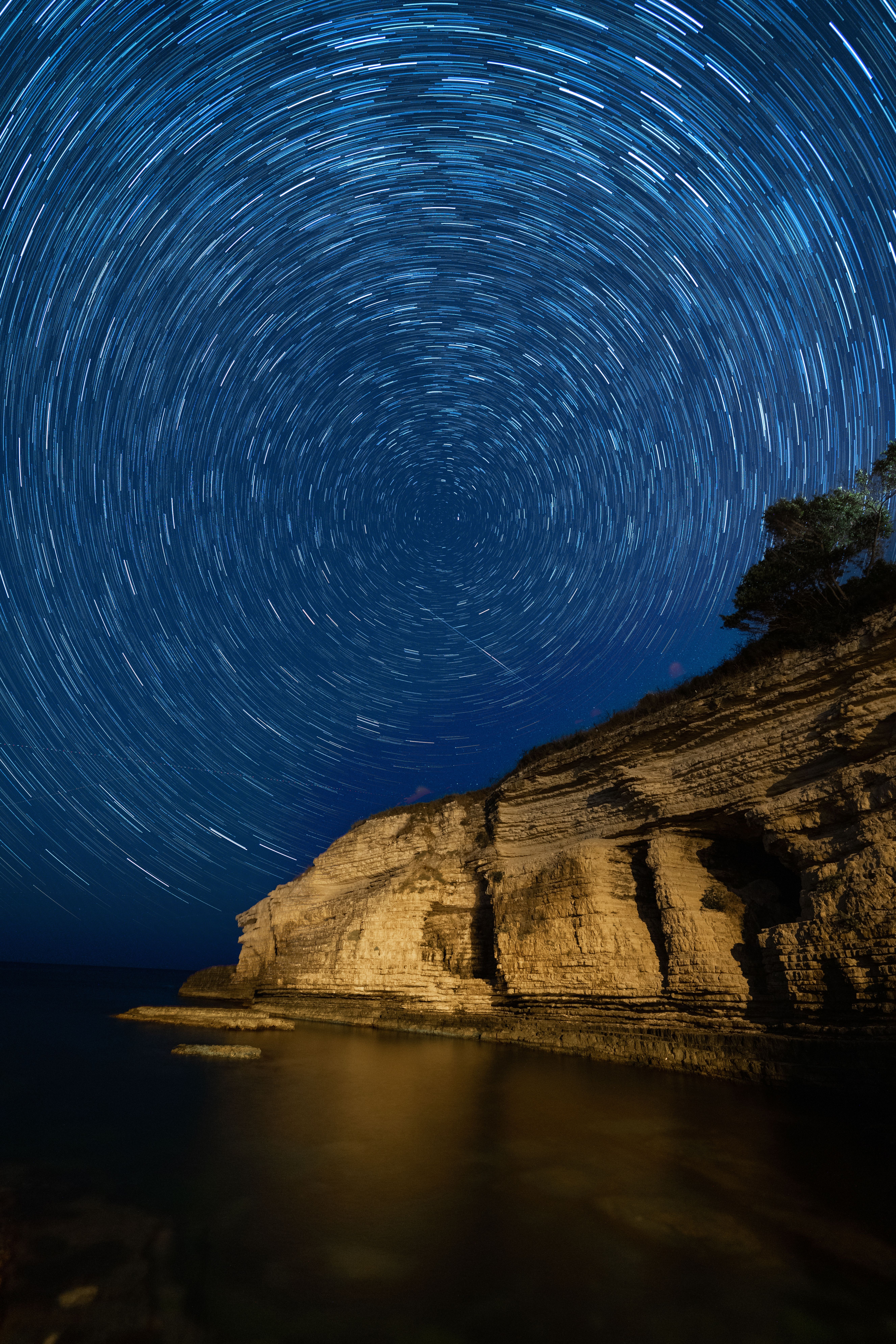 Time-Lapse of Stars Over Sea Cliff · Free Stock Photo