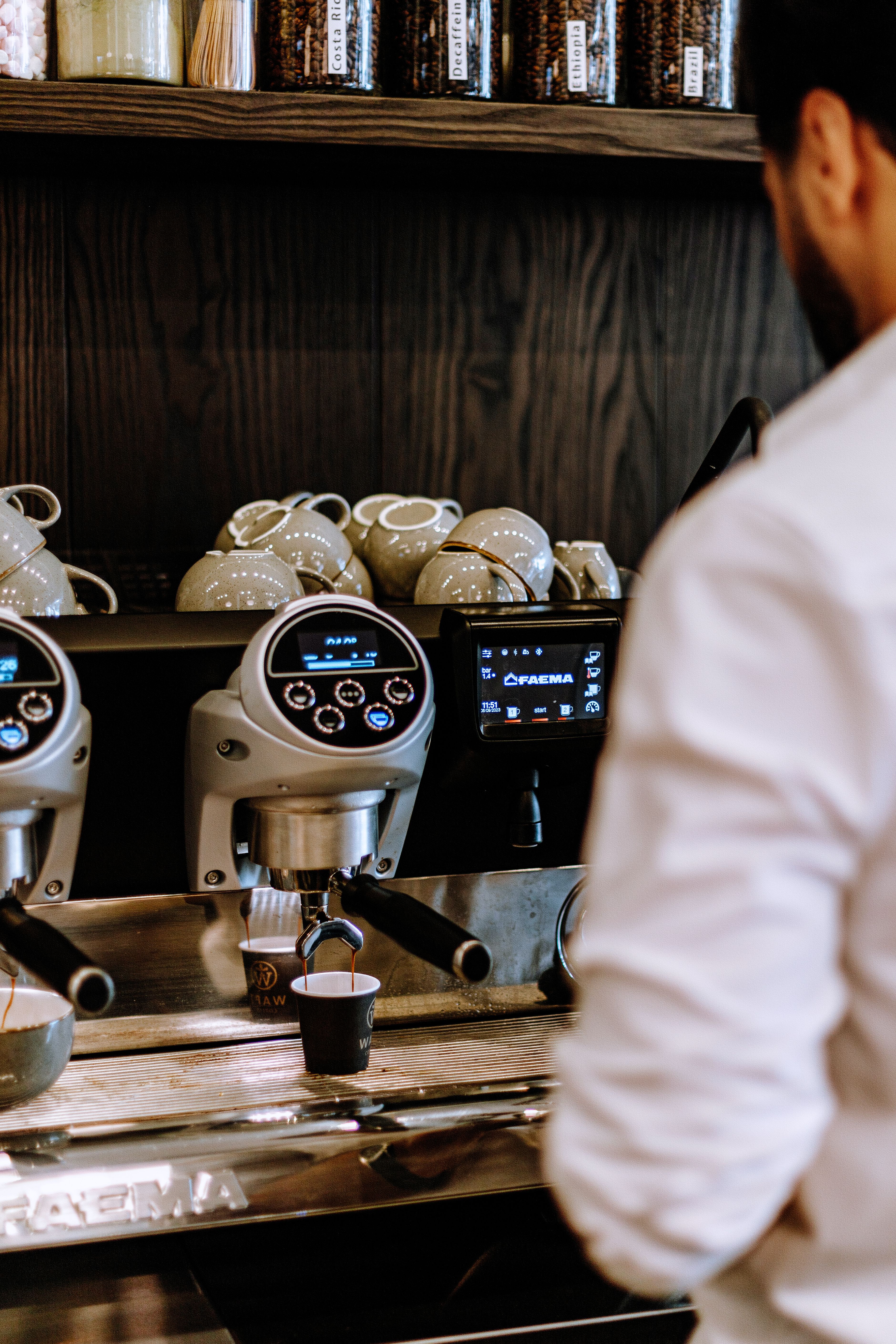 Barista Standing by a Coffee Machine · Free Stock Photo