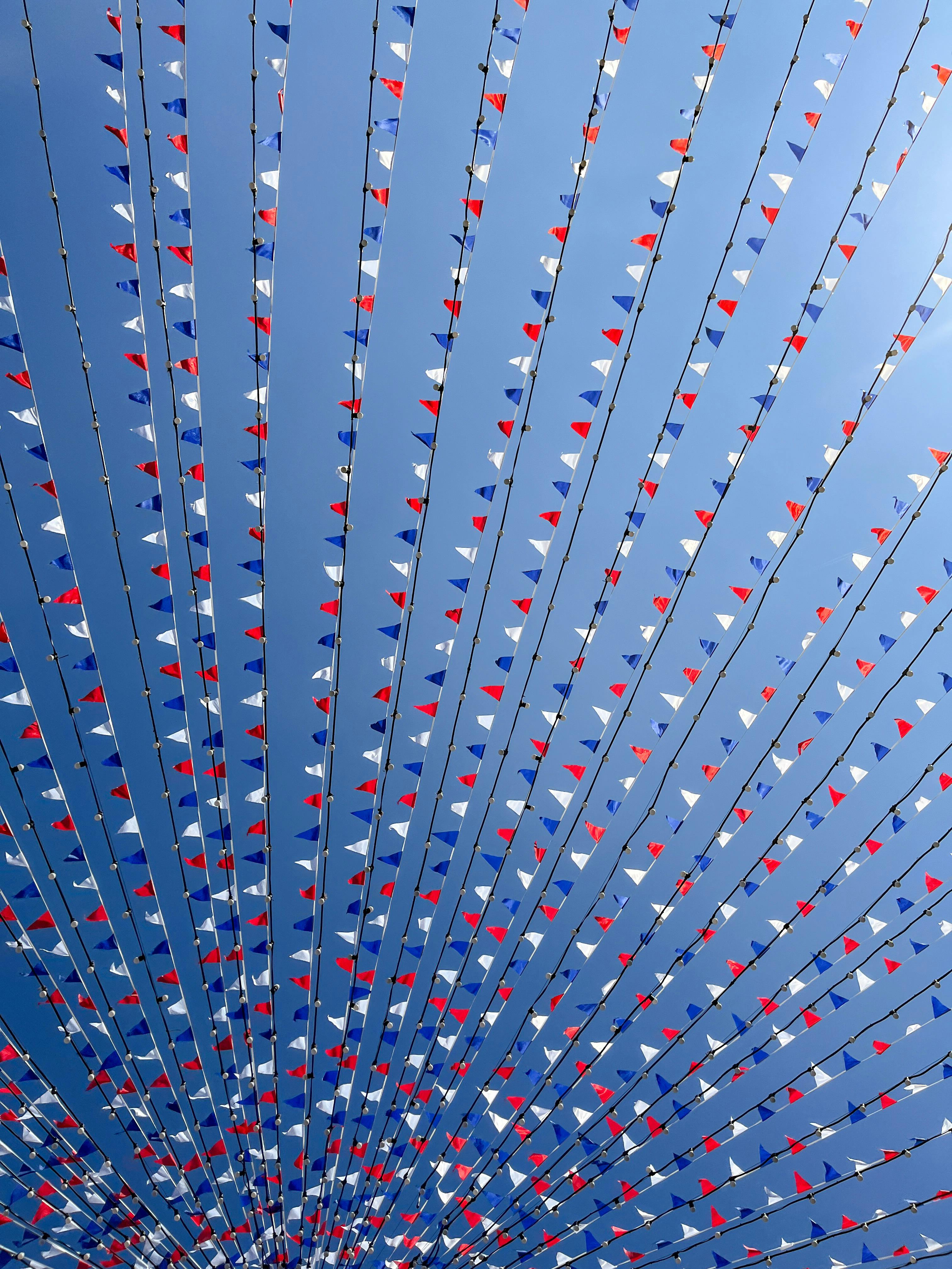 View of Colorful Flags Hanging on Lines under Clear Blue Sky · Free ...