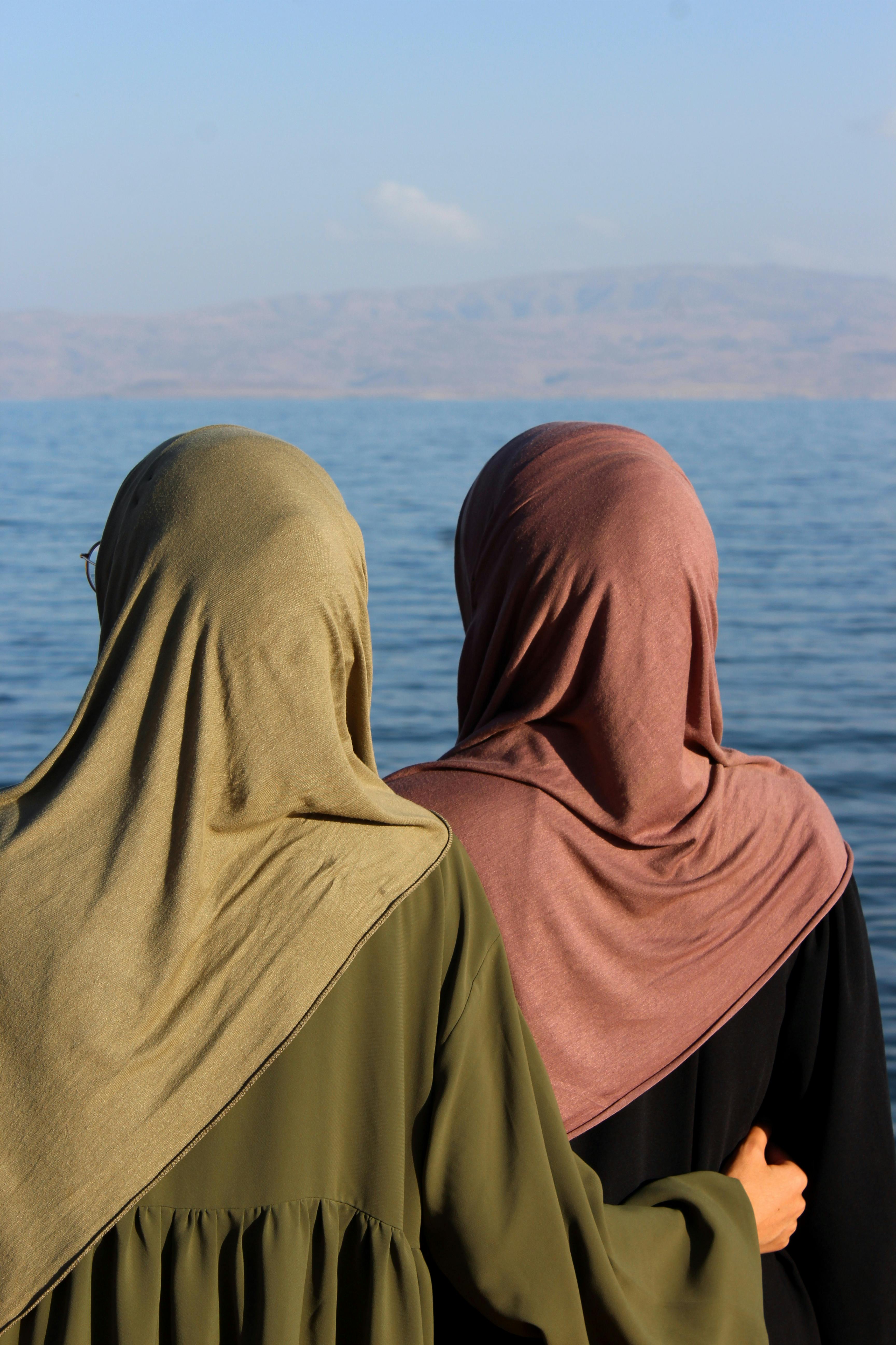 Back View of Women in Hijabs on Sea Shore · Free Stock Photo