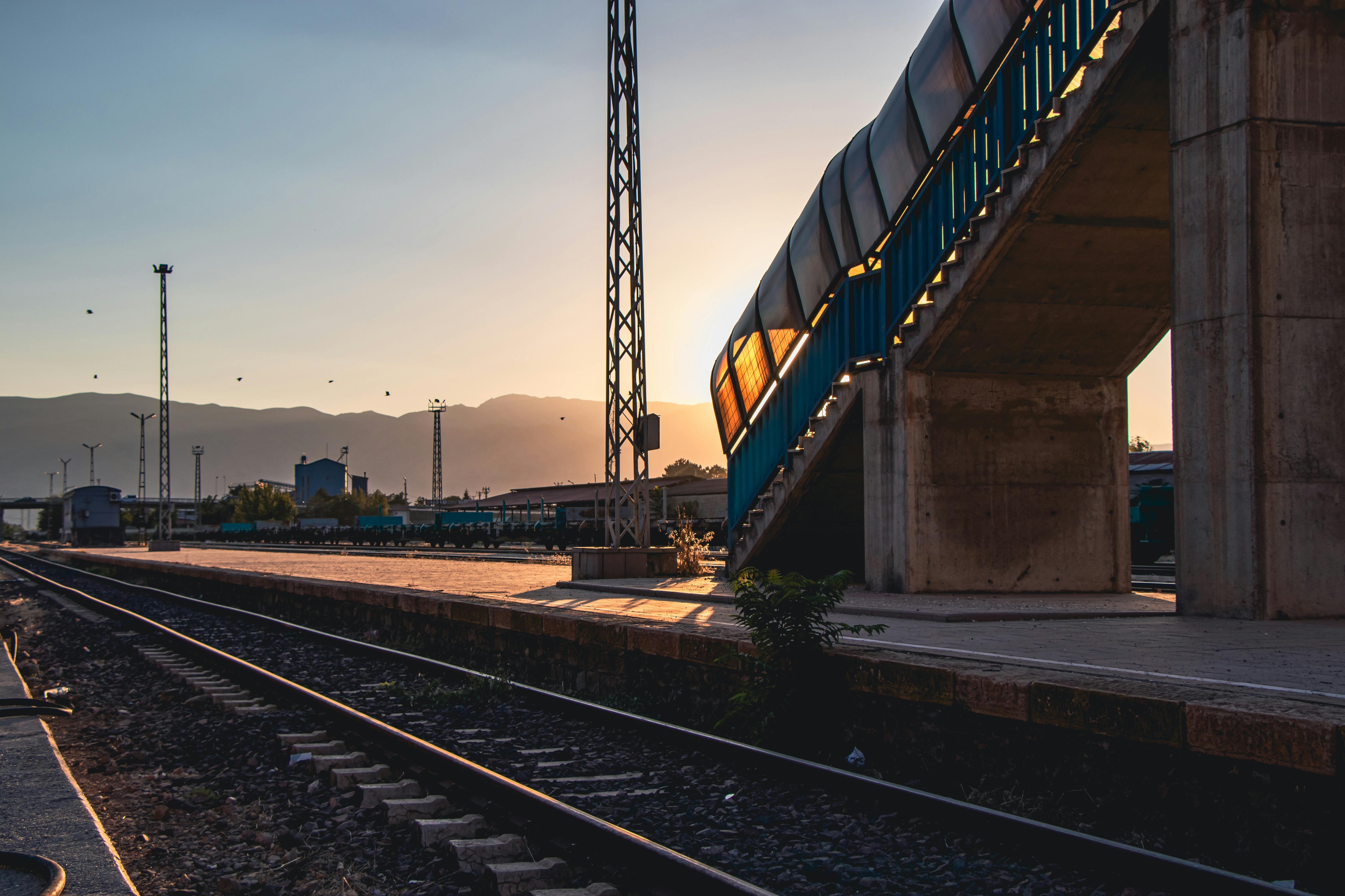 Tracks and Stairs on Railway Station on Dusk · Free Stock Photo