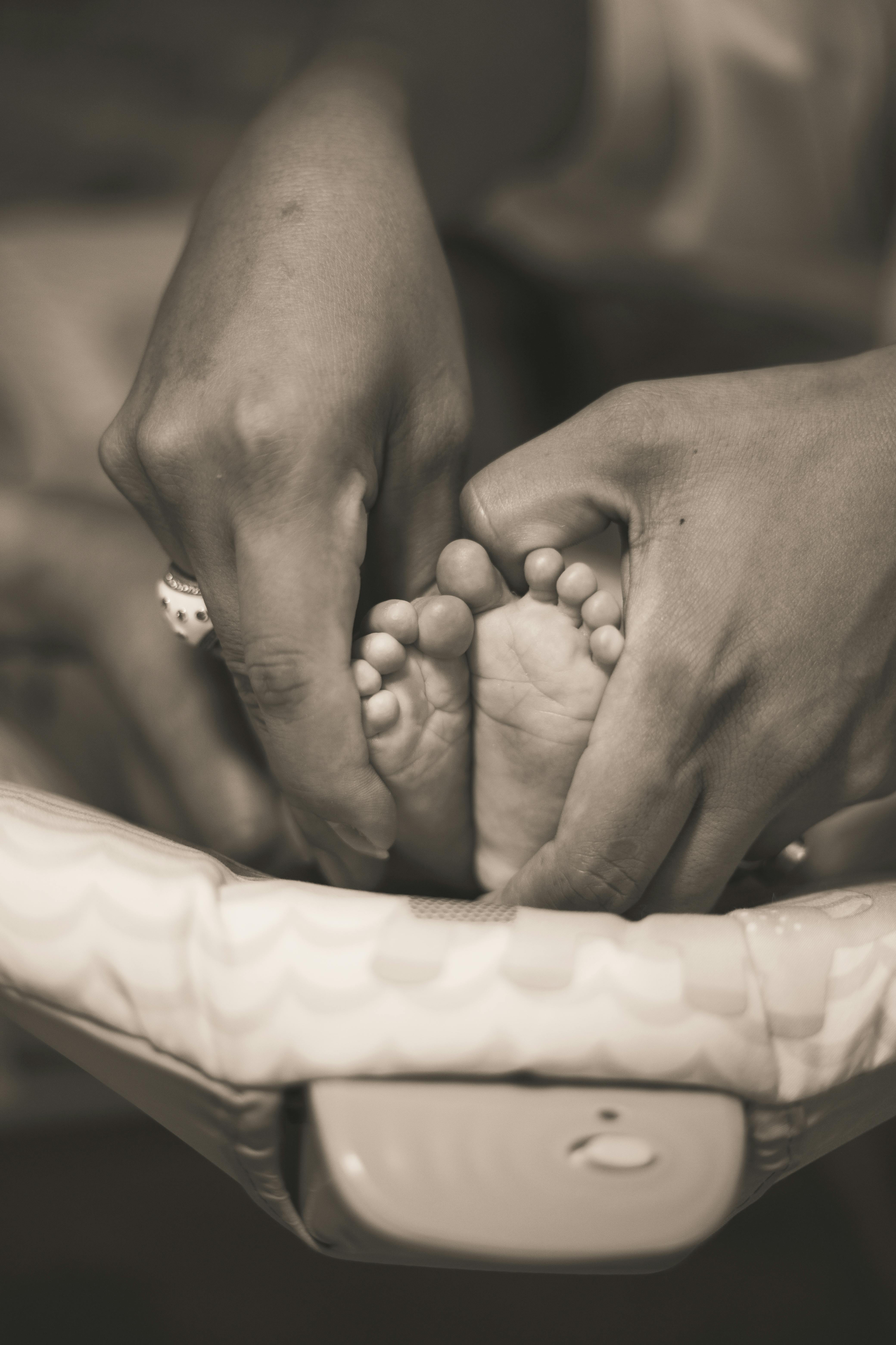 Woman Touching Babys Feet · Free Stock Photo