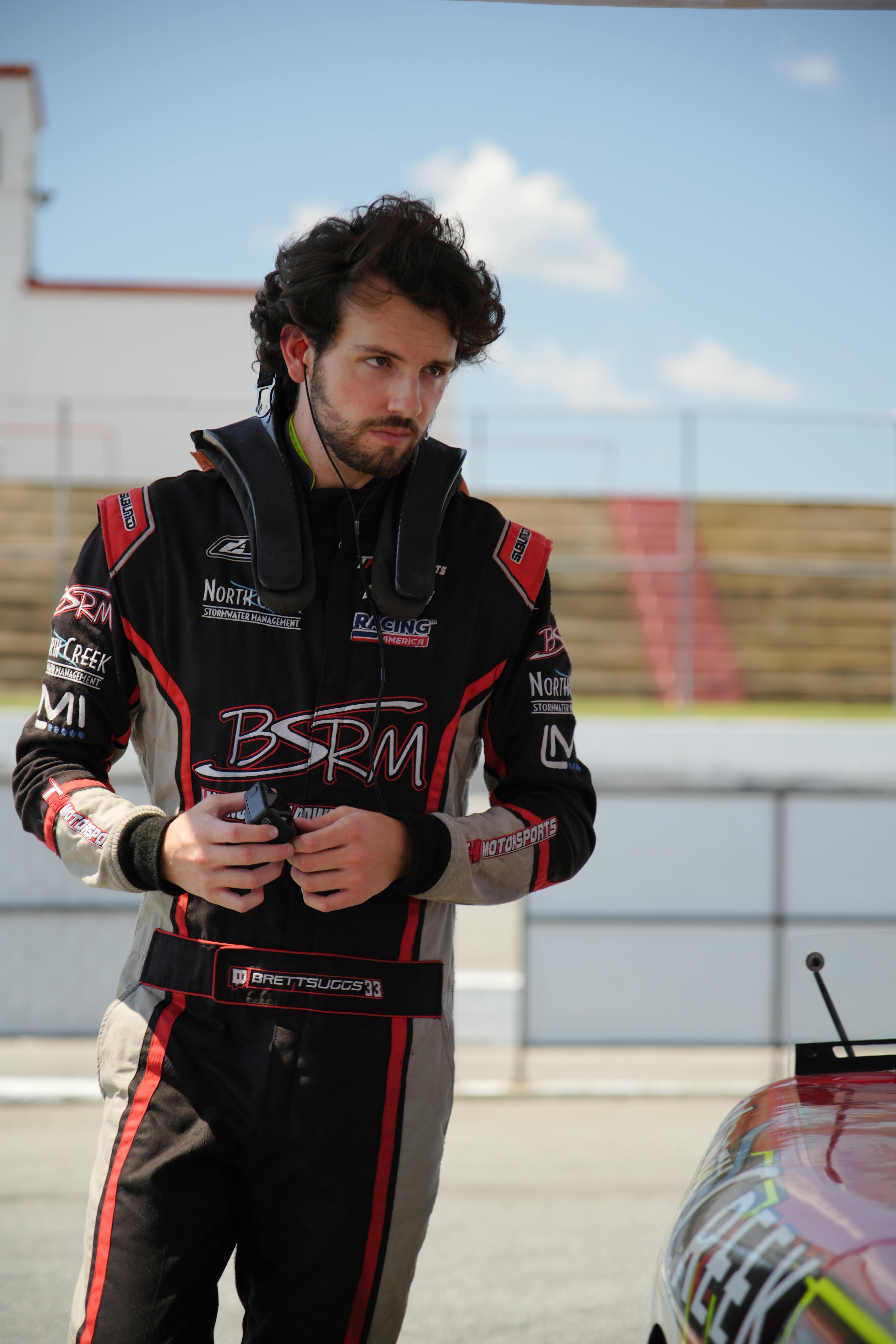 A Racing Driver in a Suit Standing next to His Car on a Circuit · Free ...