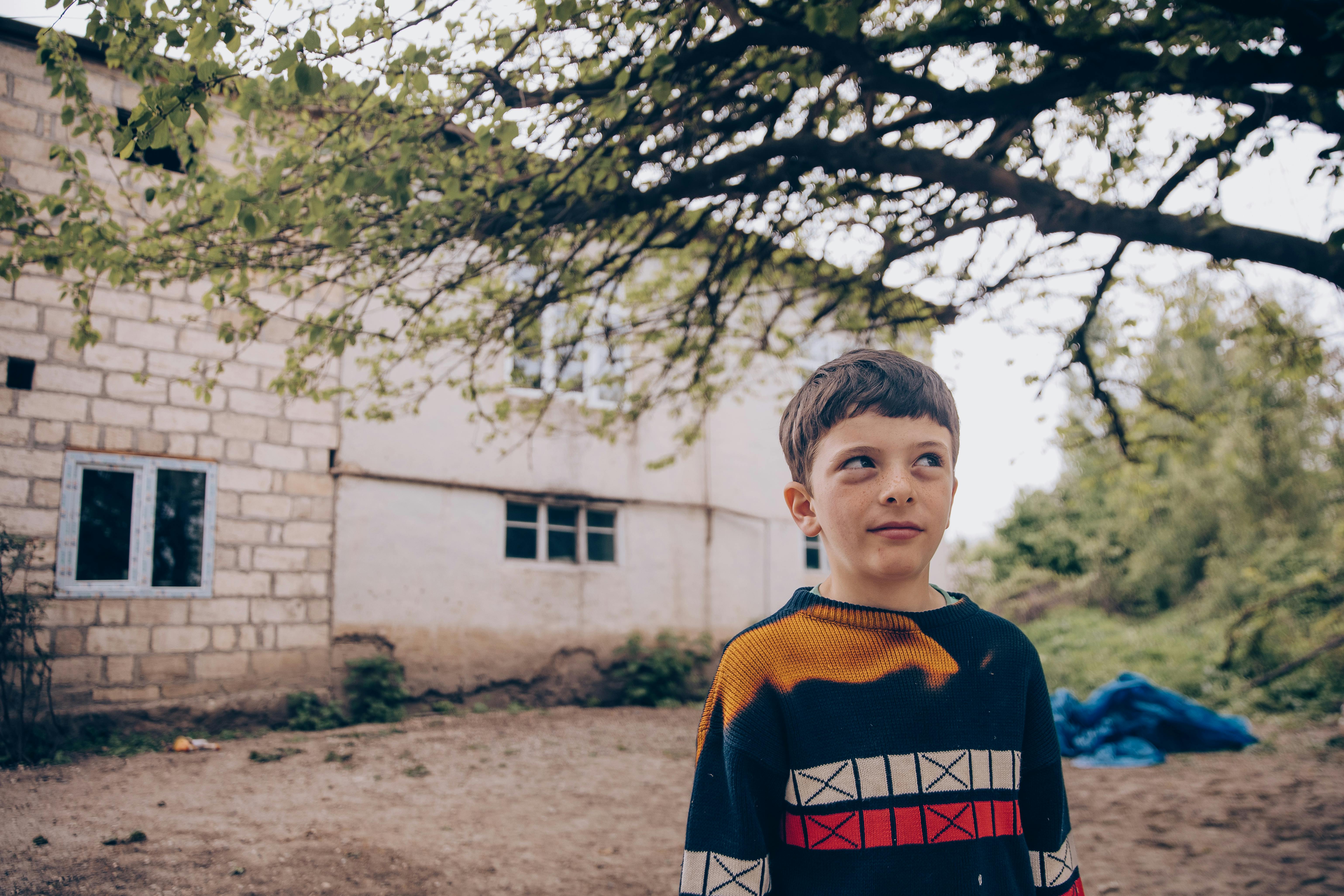 Boy Standing under Tree · Free Stock Photo