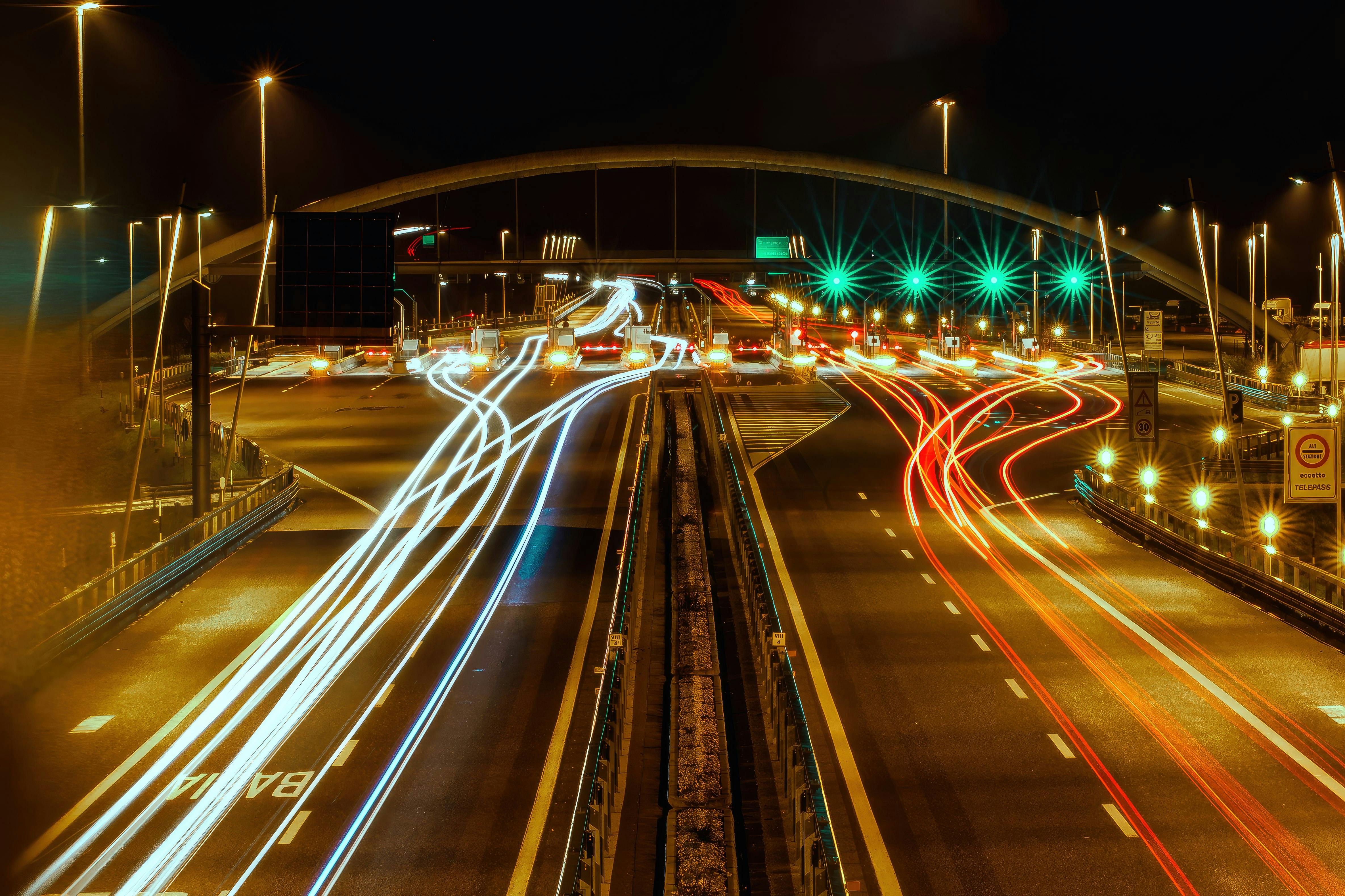 A Street at Night Photographed in Long Exposure · Free Stock Photo