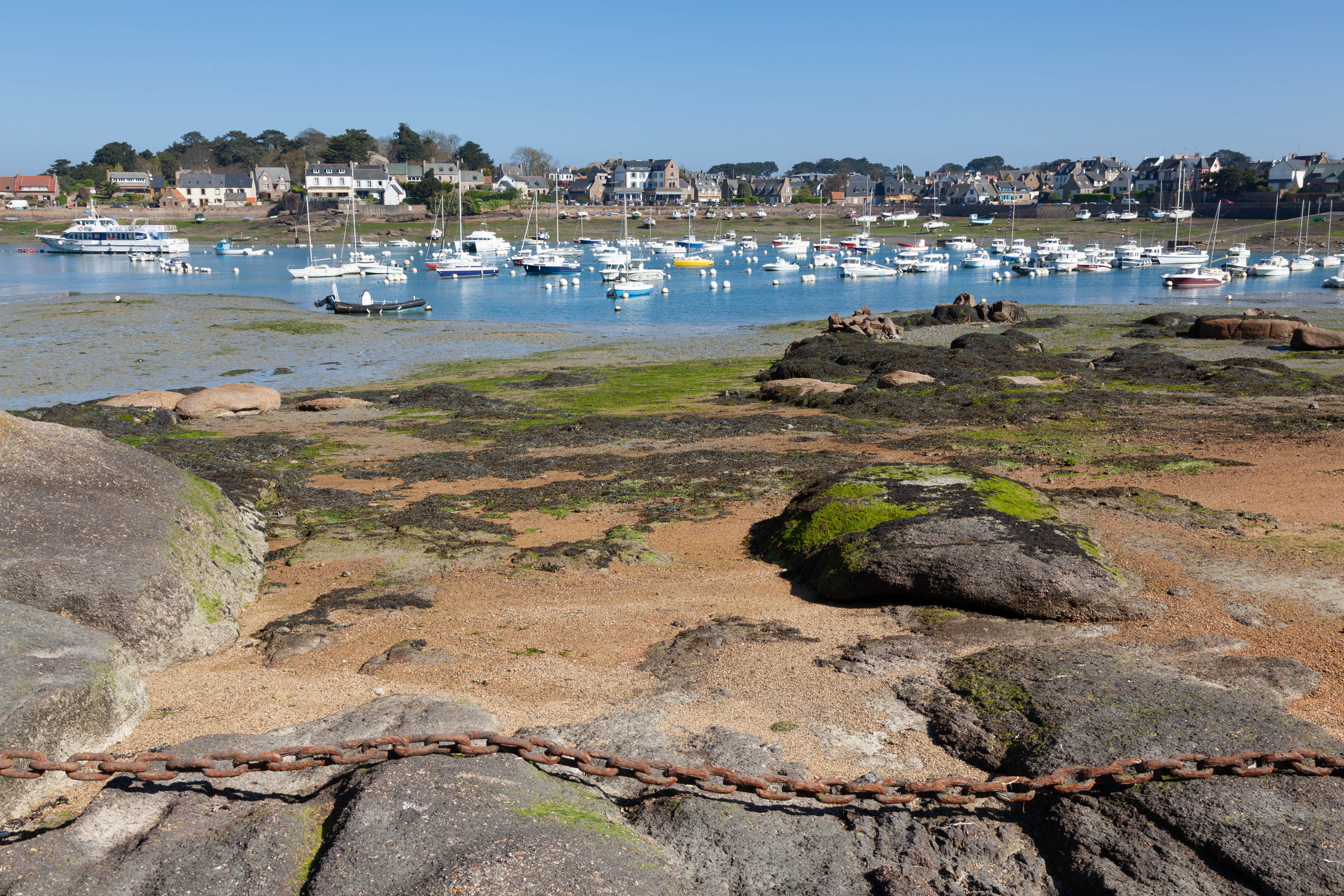 Rocks on Coast and Sailboats behind in Town in France · Free Stock Photo