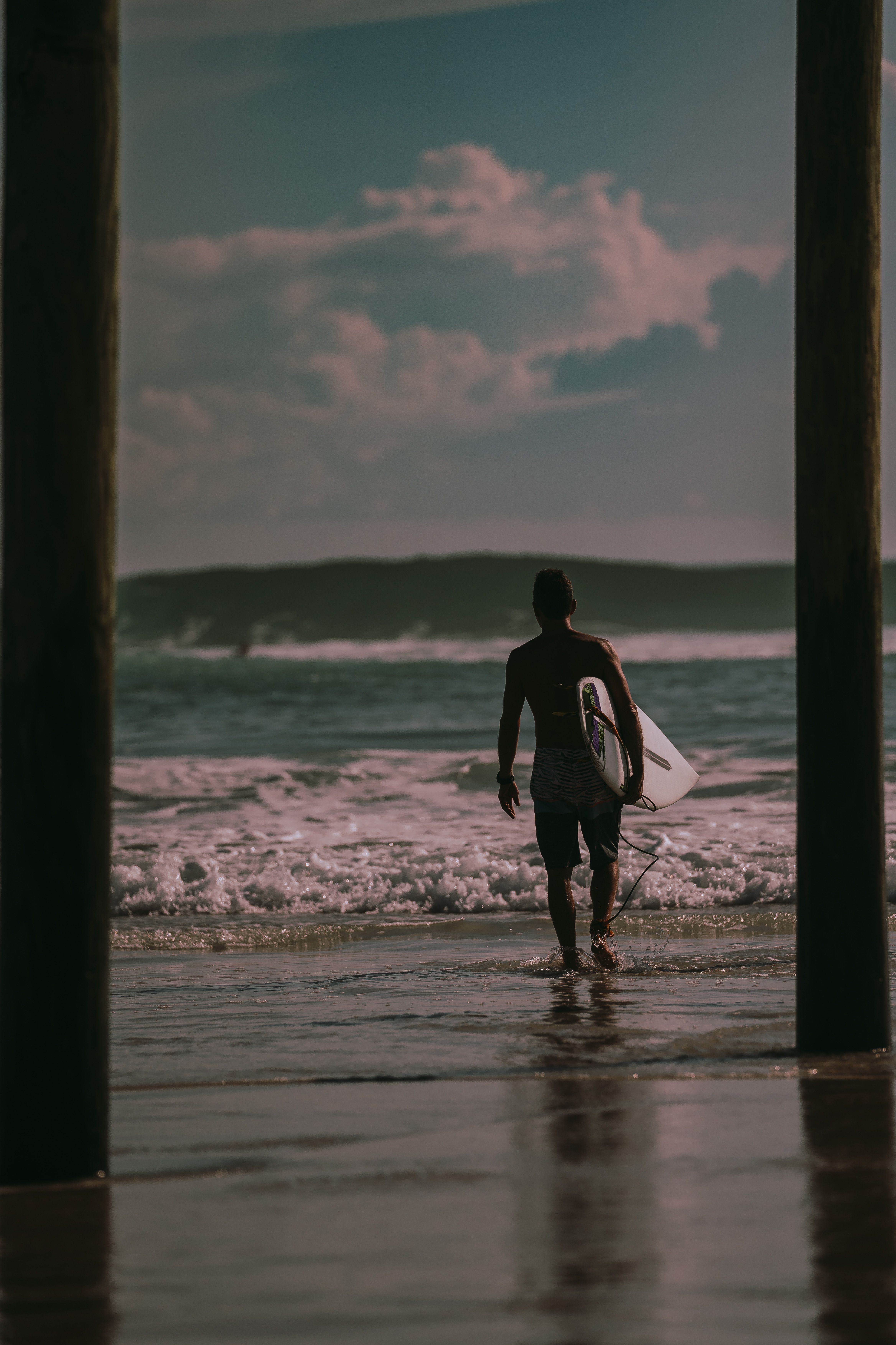 Man Carrying a Surfboard · Free Stock Photo